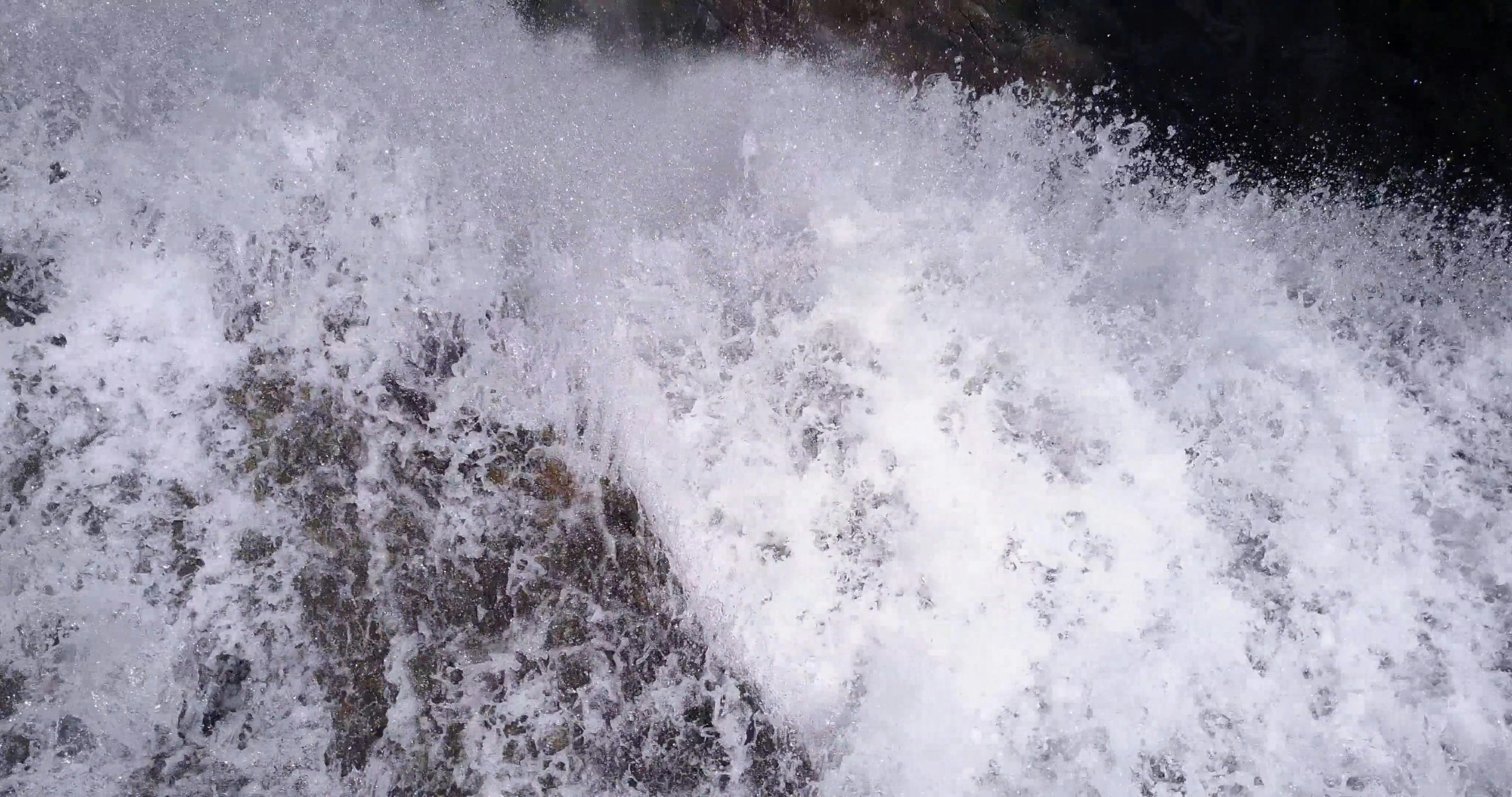Aerial Footage Of Water Rapidly Flowing Down A Fall To A Rocky River ...