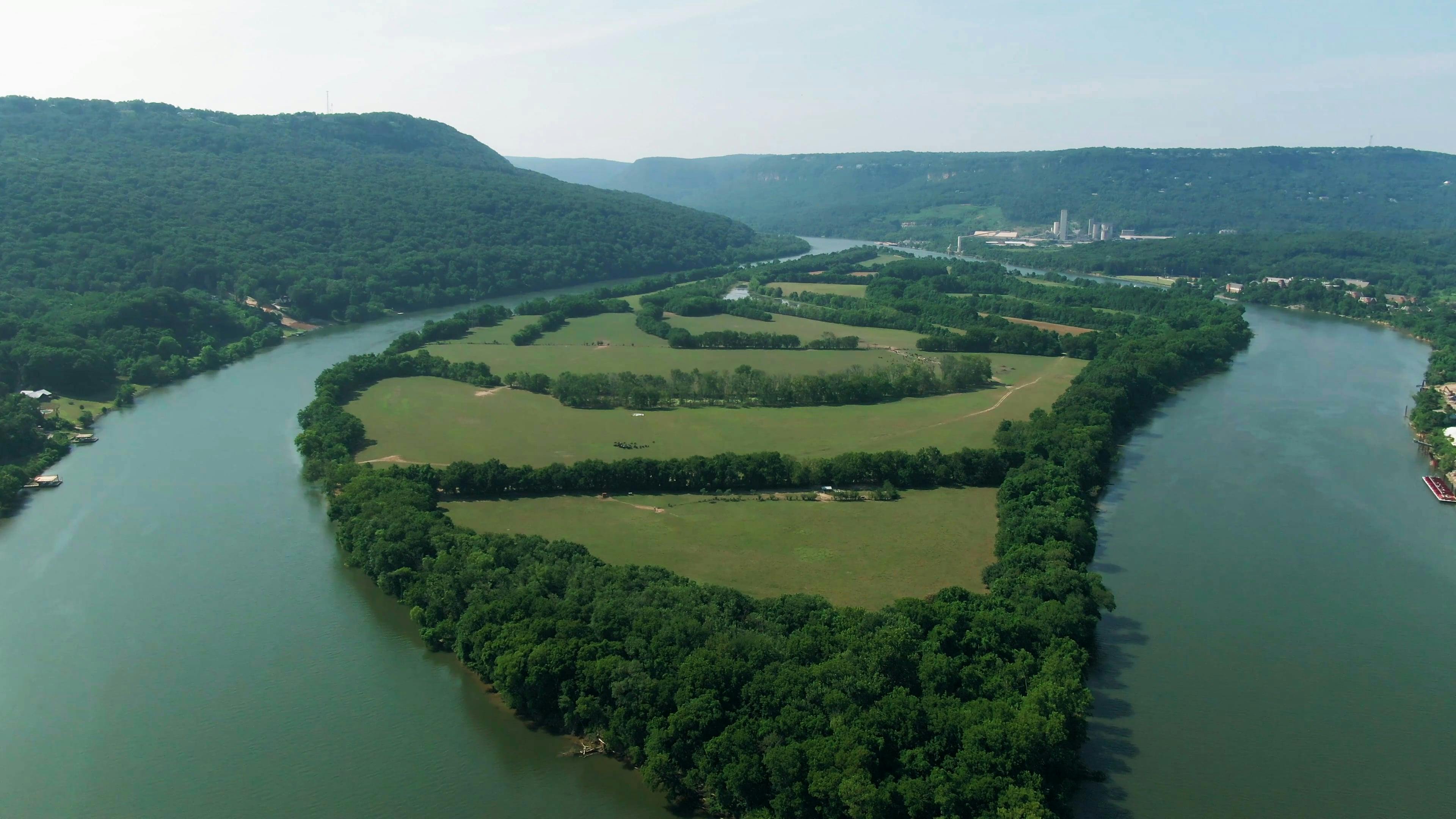 A Field Splitting A River · Free Stock Video