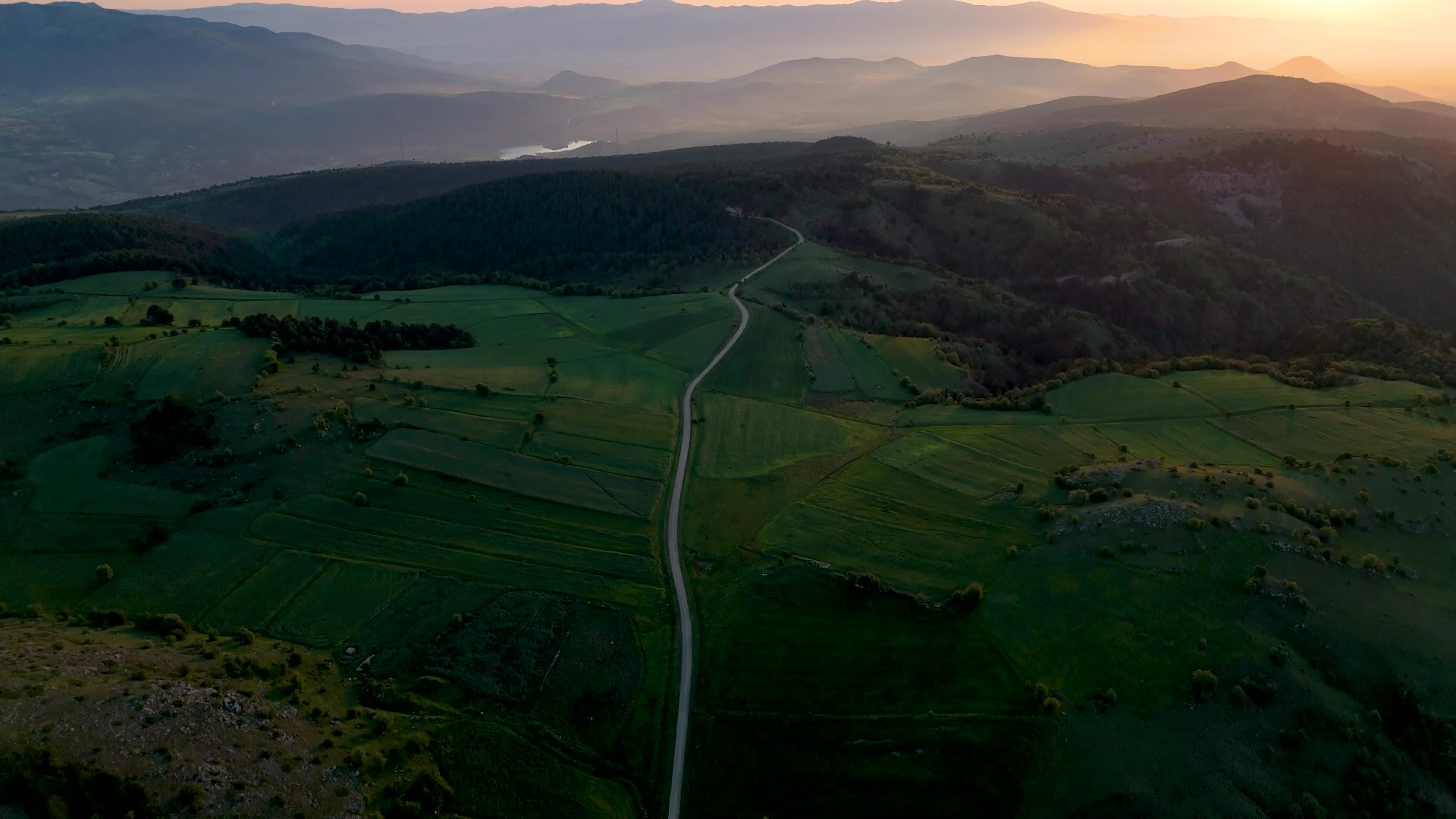 A sunset over a valley with a road running through it Free Stock Video ...