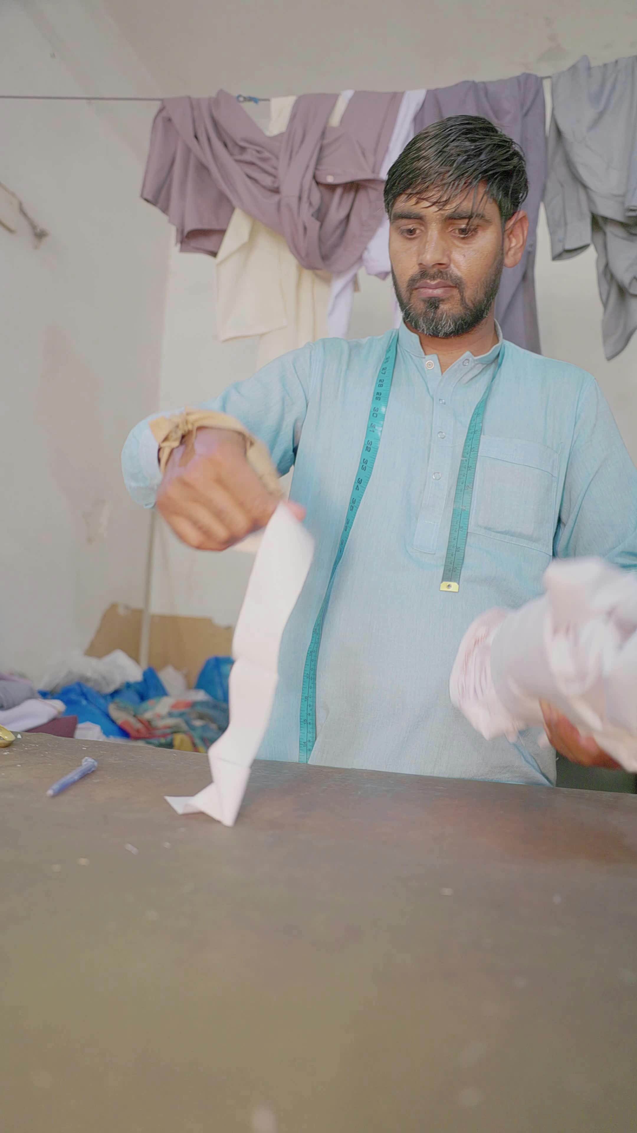 A man is making a shirt in a room Free Stock Video Footage, Royalty ...