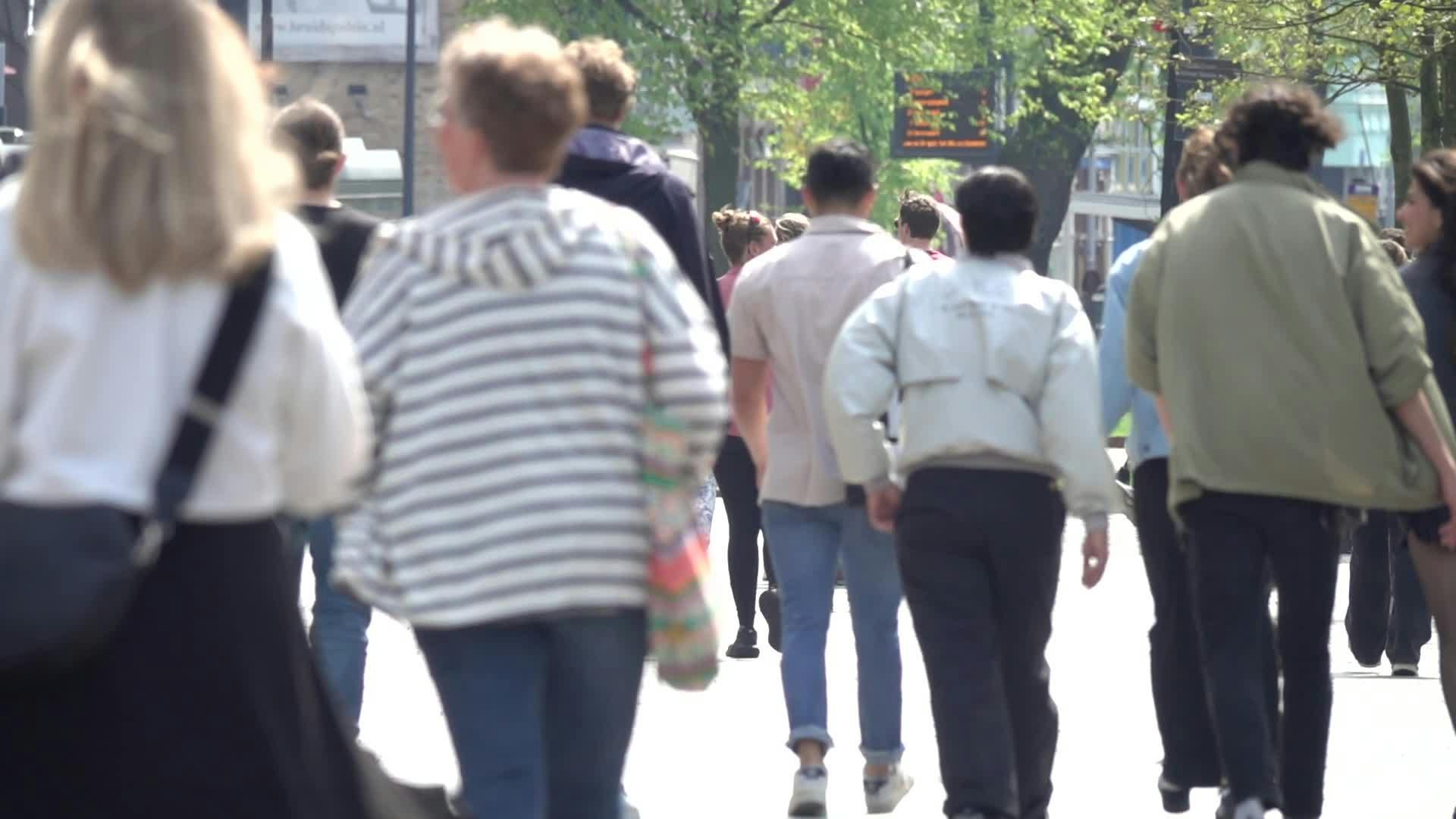 A group of people walking down a street Free Stock Video Footage ...