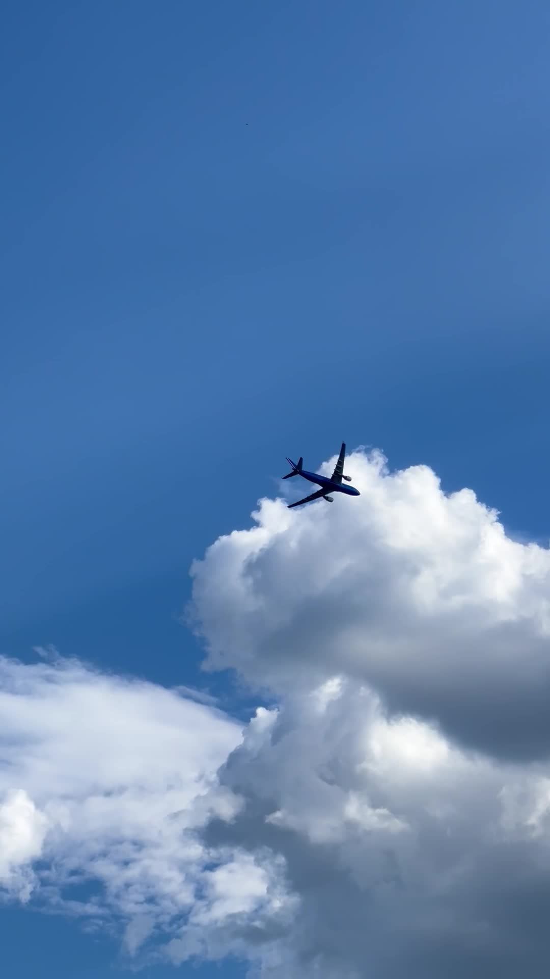 A plane flying through the clouds with blue sky Free Stock Video ...