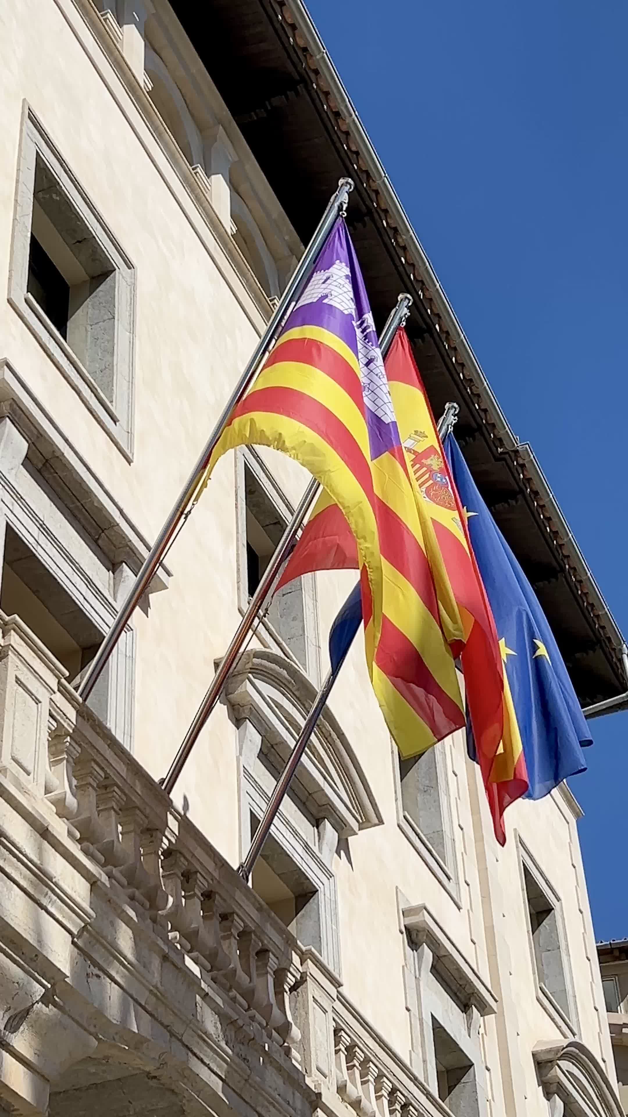 The flag of catalonia is flying in front of a building Free Stock Video ...