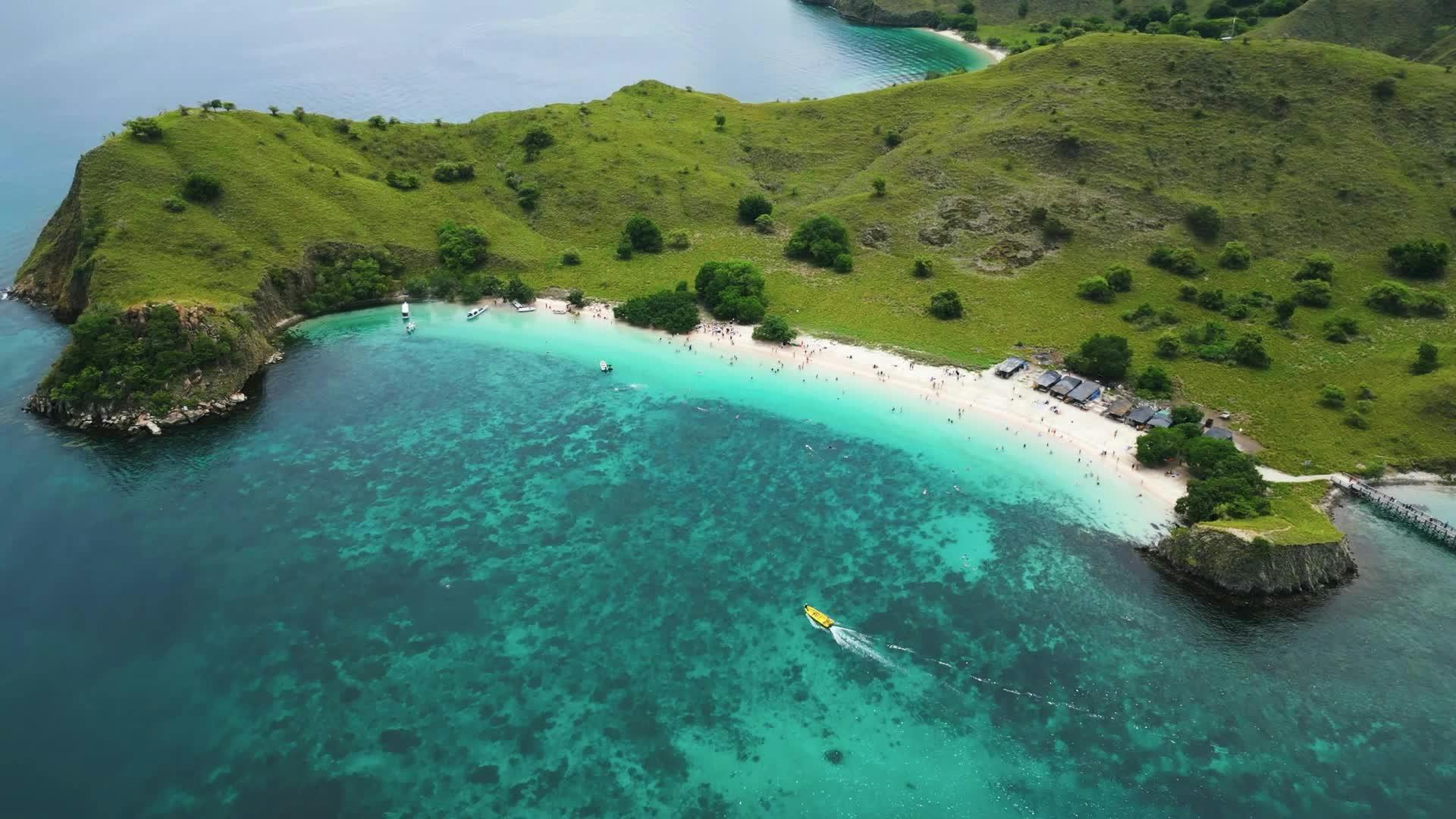 An aerial view of a beach with a boat and a small island Free Stock ...
