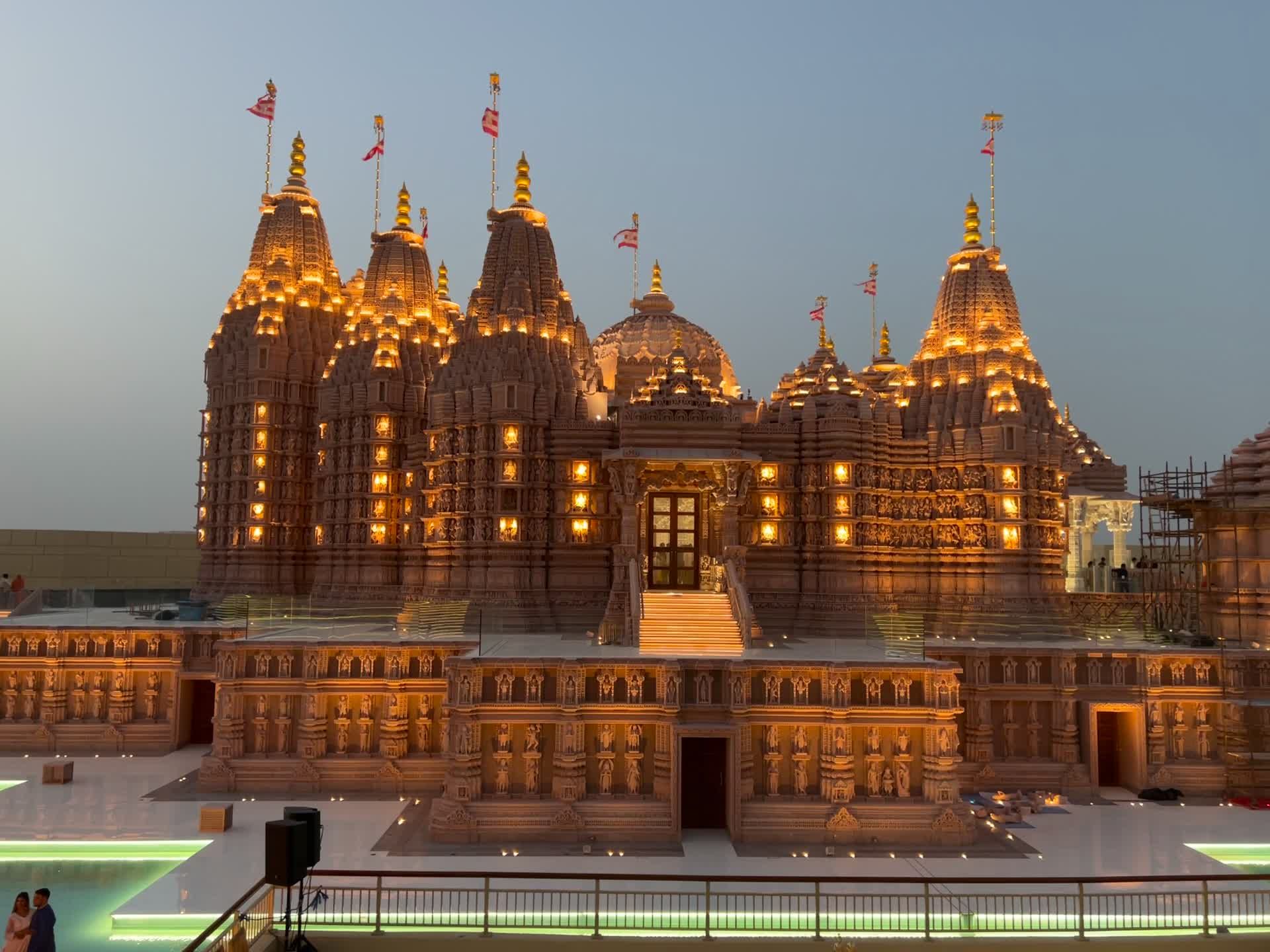 The temple is lit up at night with a large statue Free Stock Video ...