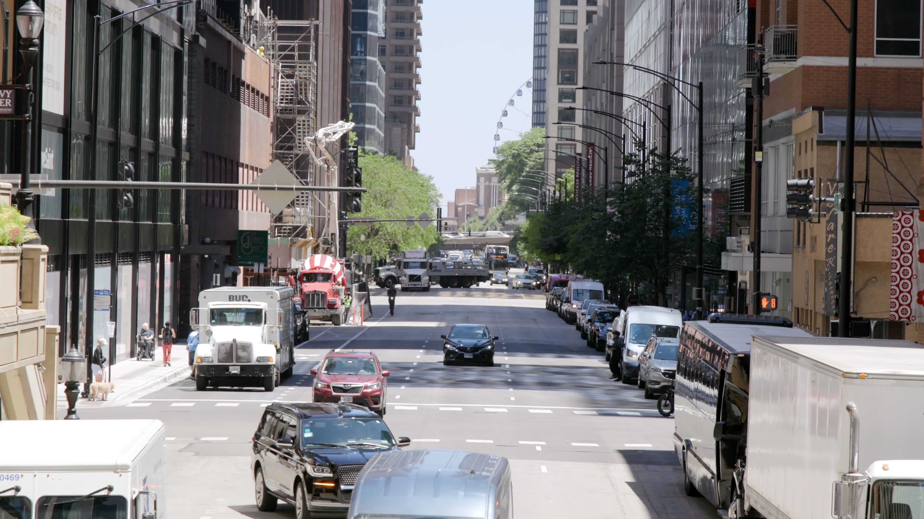 A city street with cars and trucks driving down it Free Stock Video ...