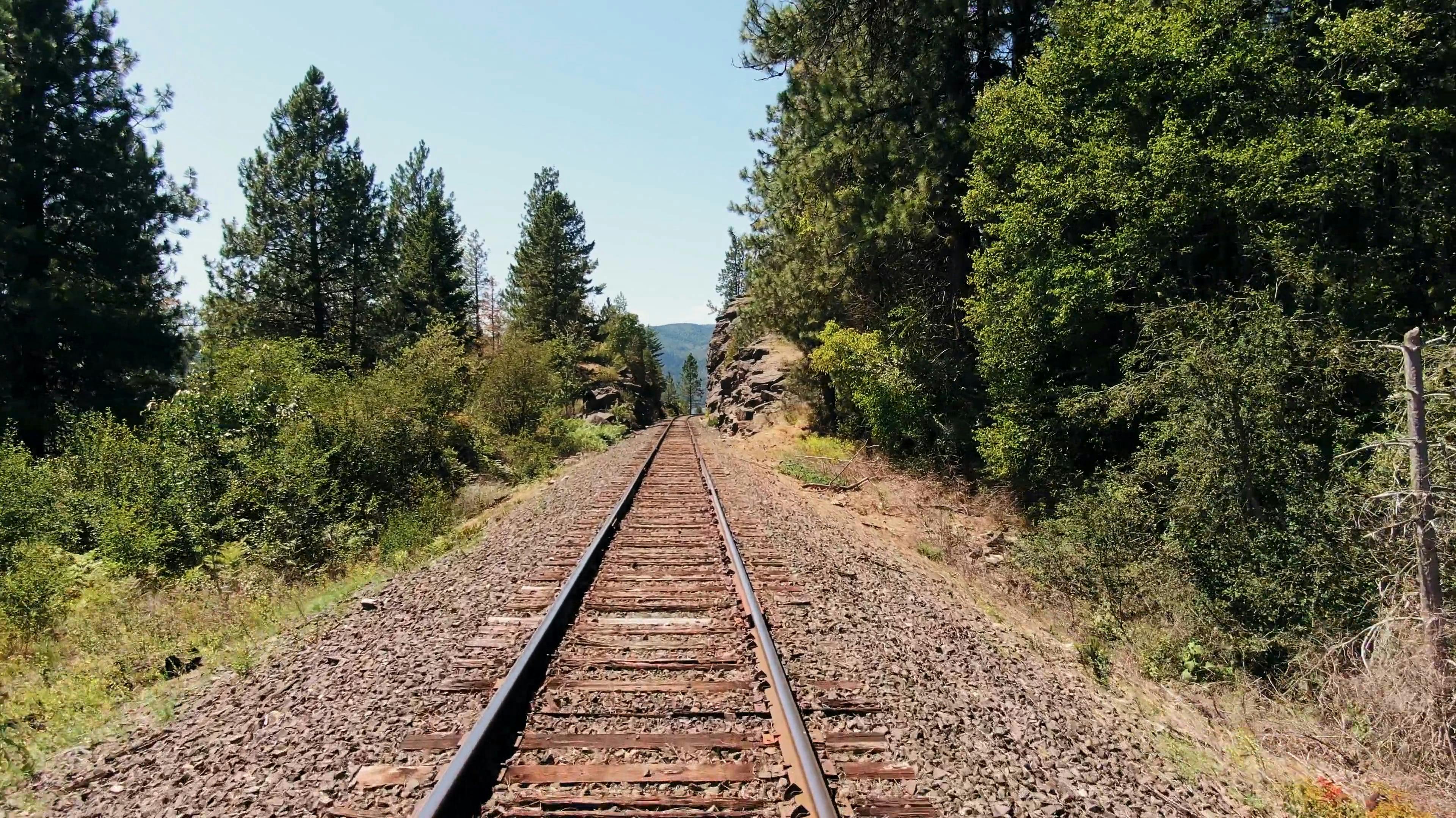 A Railroad Track Cuts Through The Rocky Mountain Side · Free Stock Video