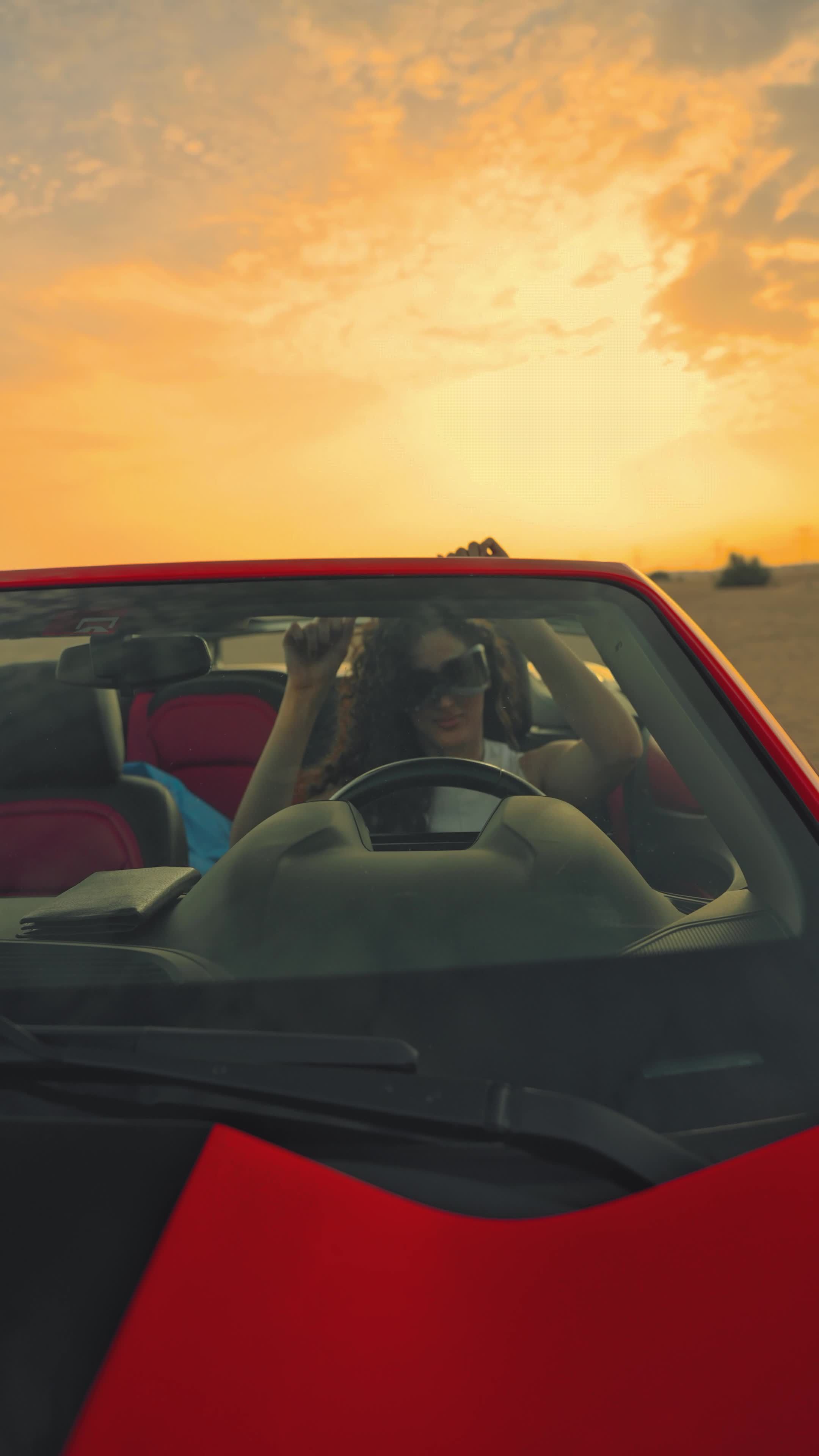 A woman driving a red sports car on the beach Free Stock Video Footage ...