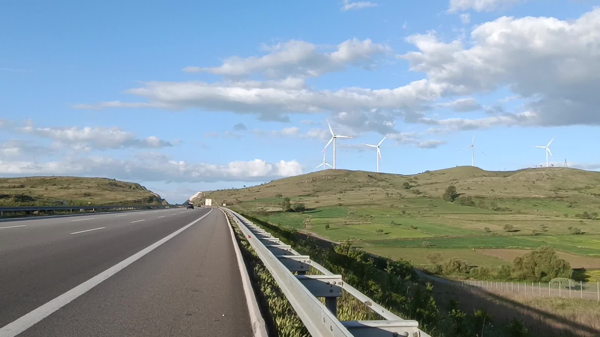 A highway with wind turbines in the background Free Stock Video Footage ...
