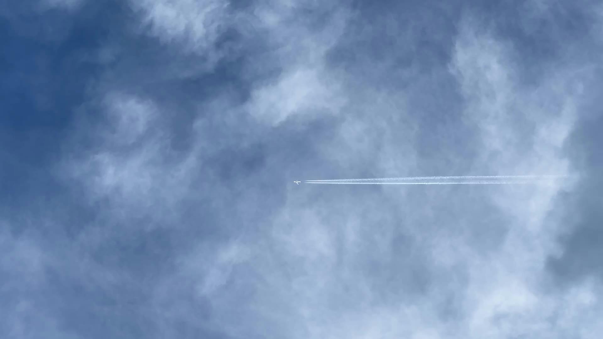 A jetliner flying through the sky with a contrail Free Stock Video ...