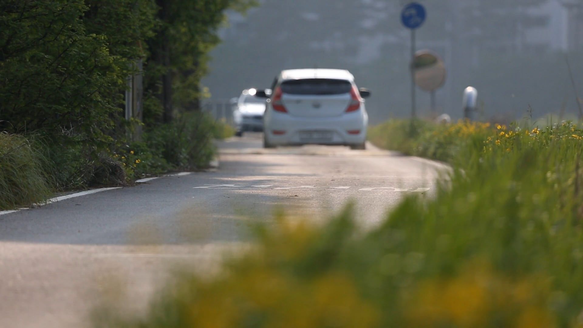 Low-Angle Footage Of Vehicular Traffic On A Narrow Street Free Stock ...
