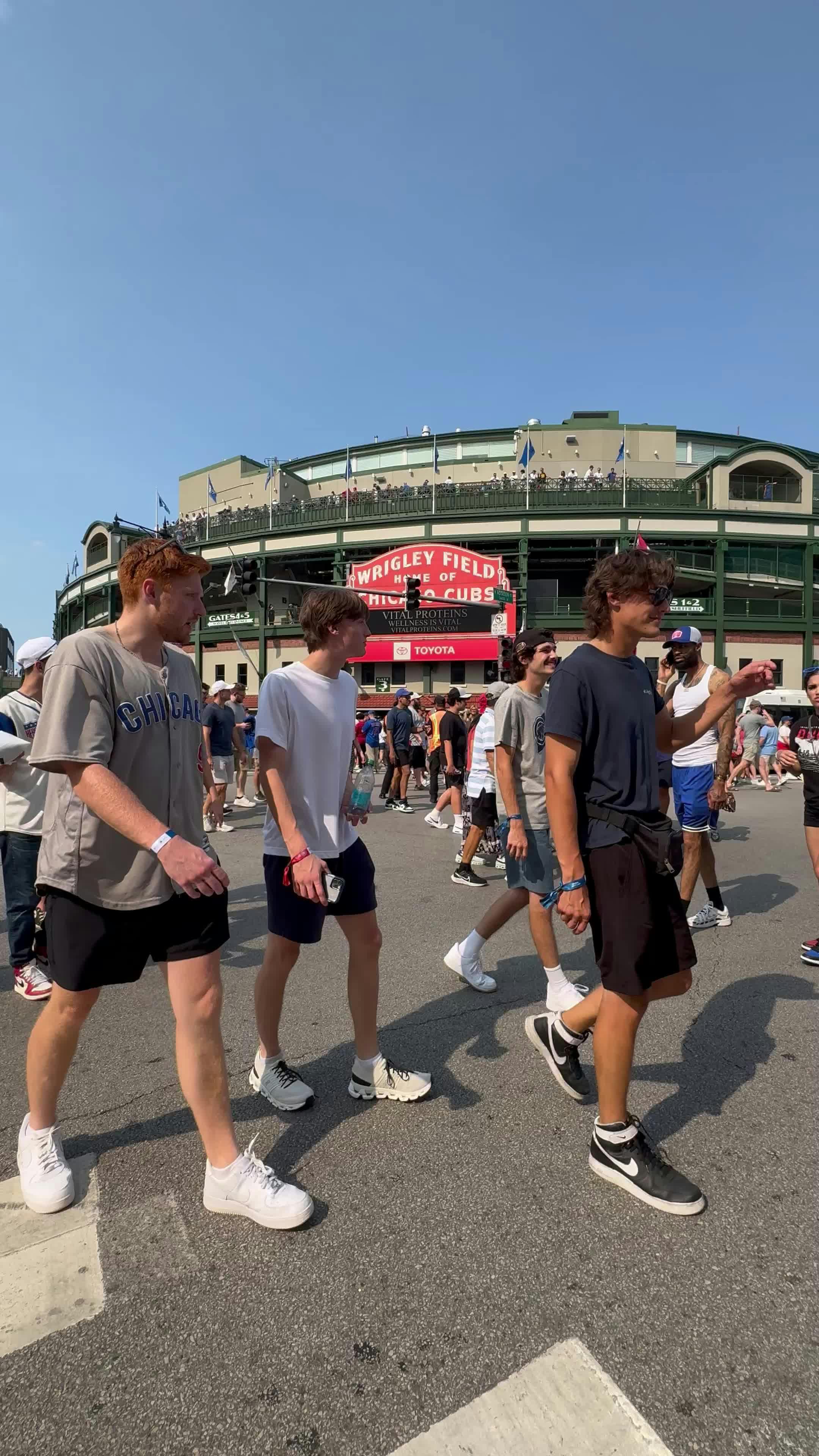 People walking on a street near a baseball stadium Free Stock Video ...