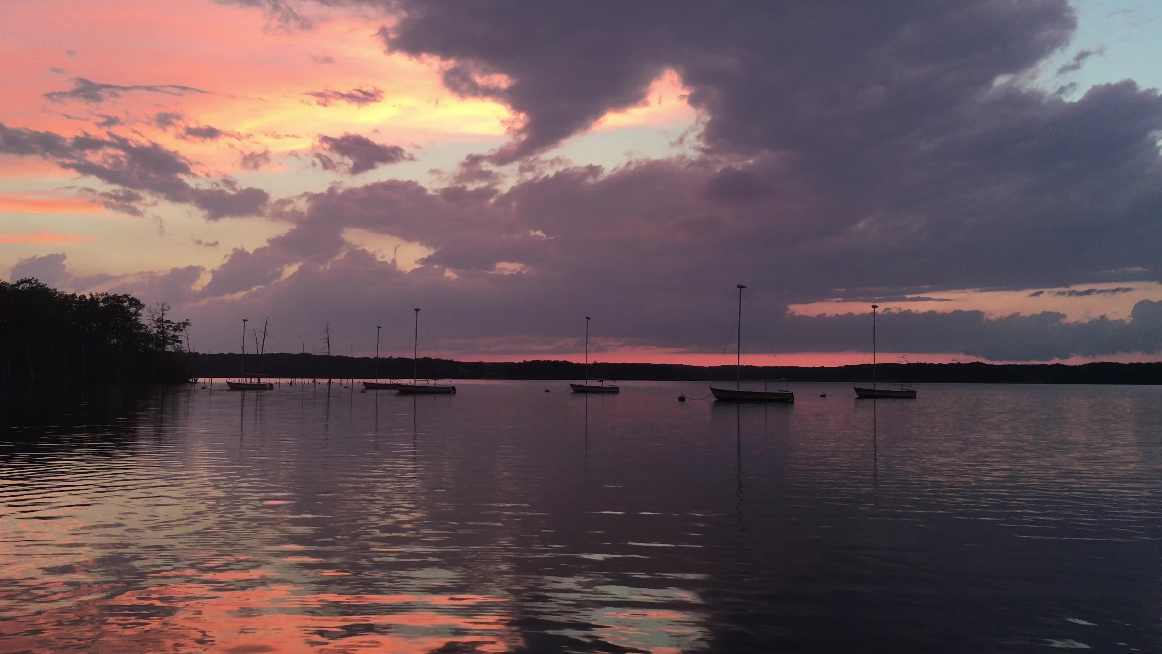 A sunset over the water with boats in the distance Free Stock Video ...