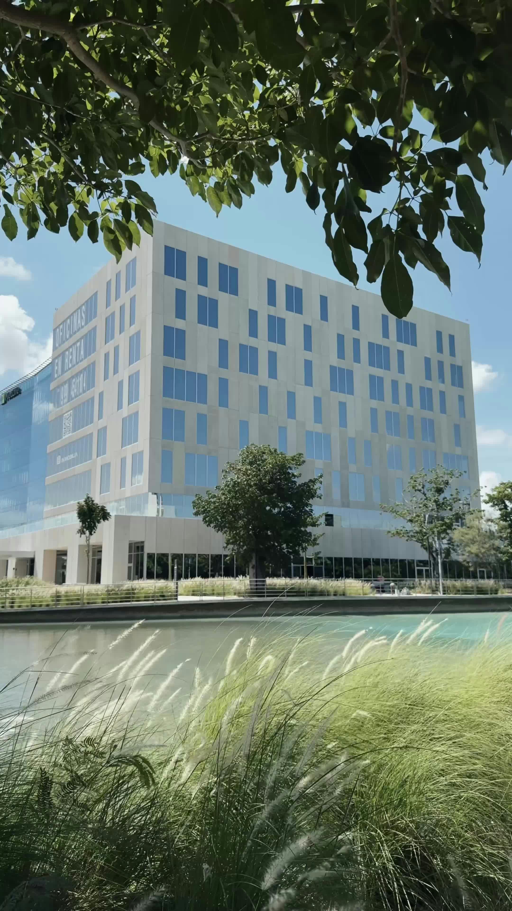 A large building with a large grassy area in front of it Free Stock ...