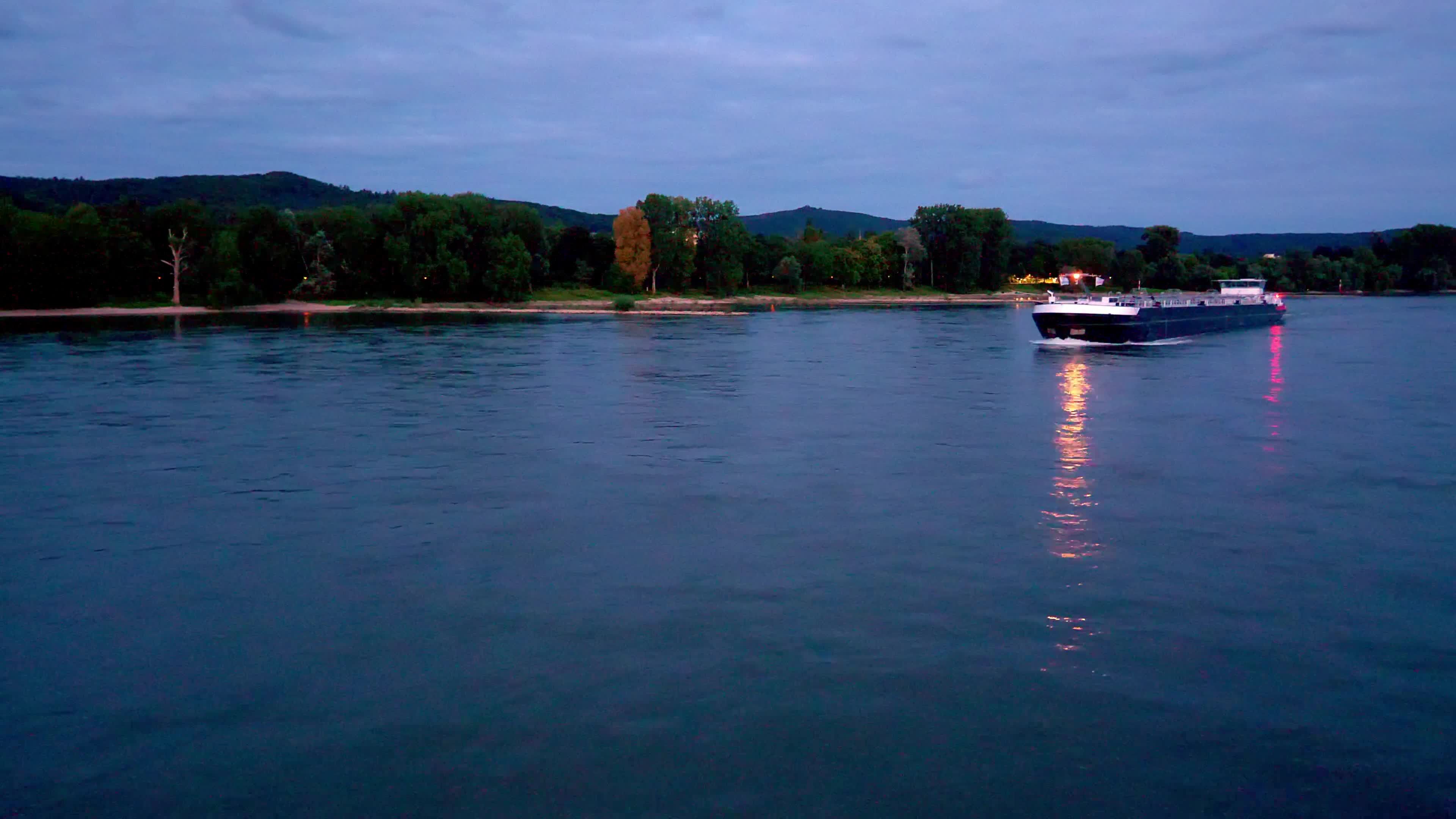 A large barge traveling down a river at night Free Stock Video Footage ...
