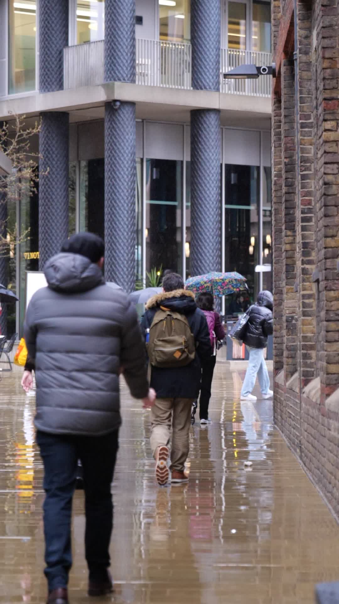 A man walking down a sidewalk in the rain Free Stock Video Footage ...