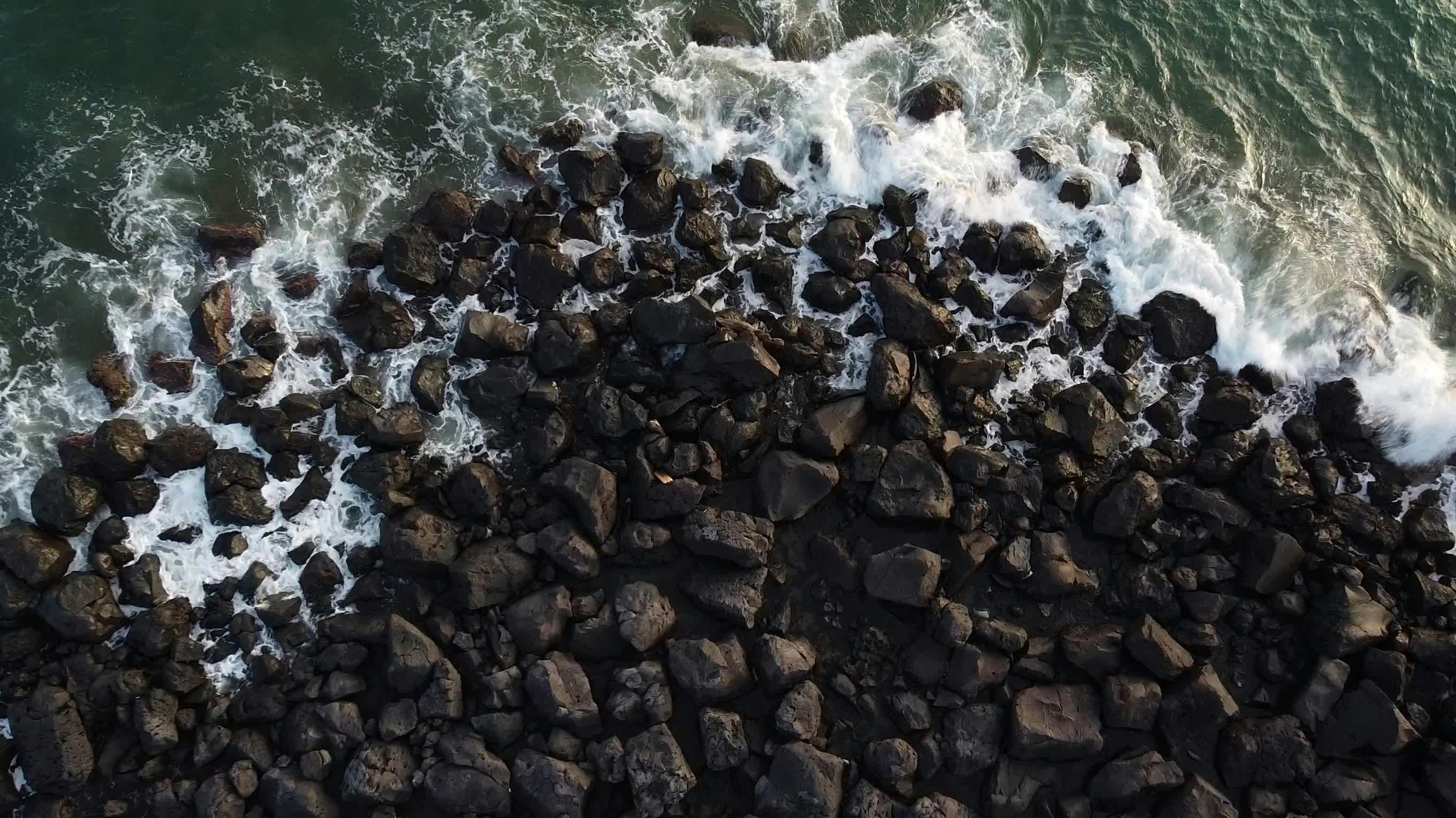 An aerial view of the ocean and rocks Free Stock Video Footage, Royalty ...