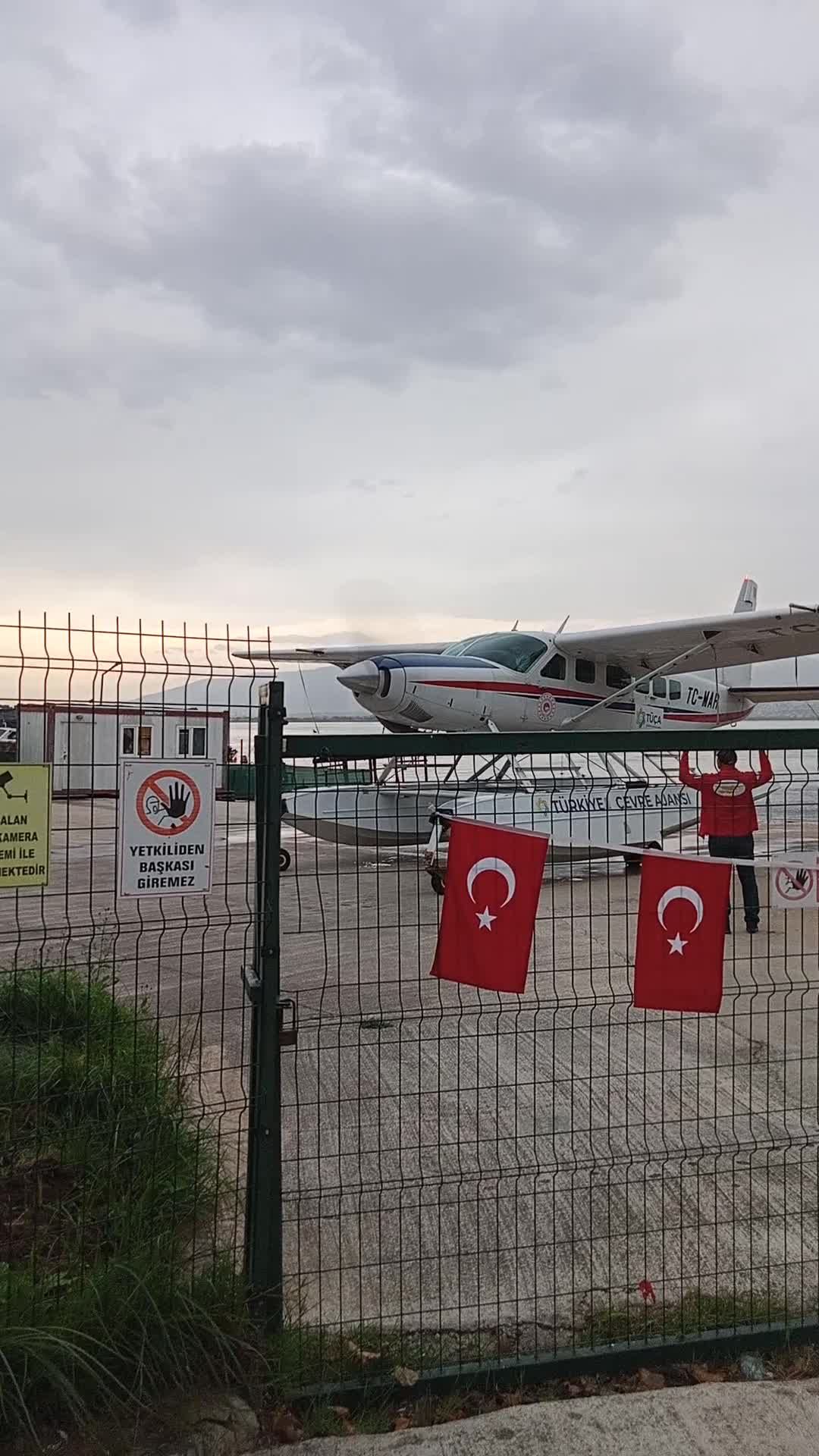 A plane is parked at the gate of a fenced in area Free Stock Video ...