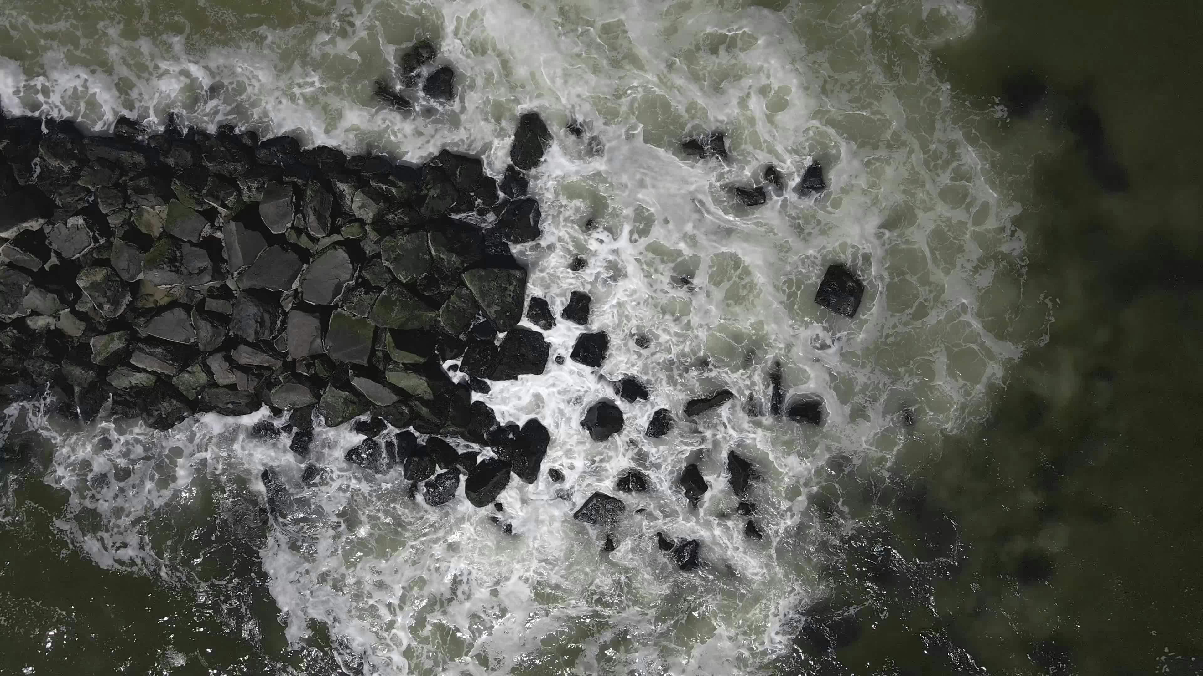 An aerial view of a large rock in the ocean Free Stock Video Footage ...