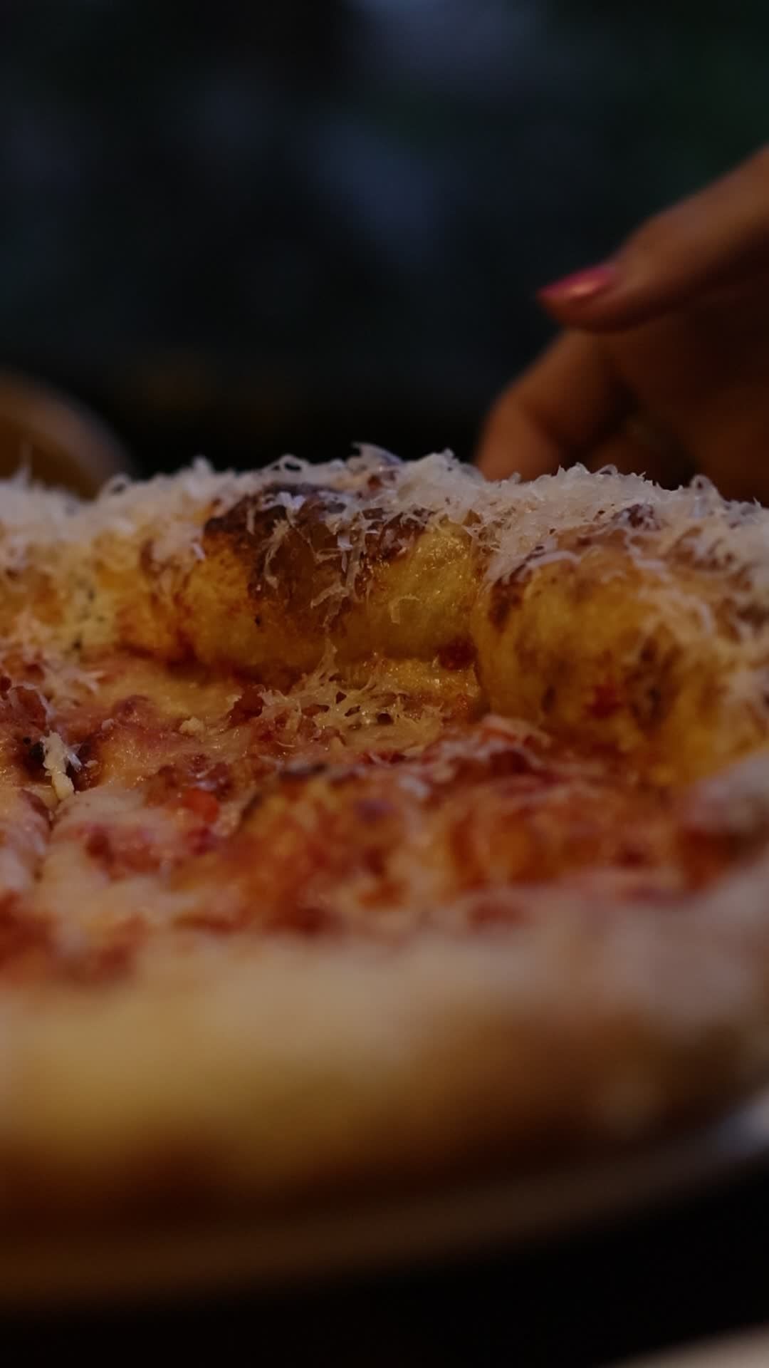 A slice of pizza is being held up to the camera Free Stock Video ...