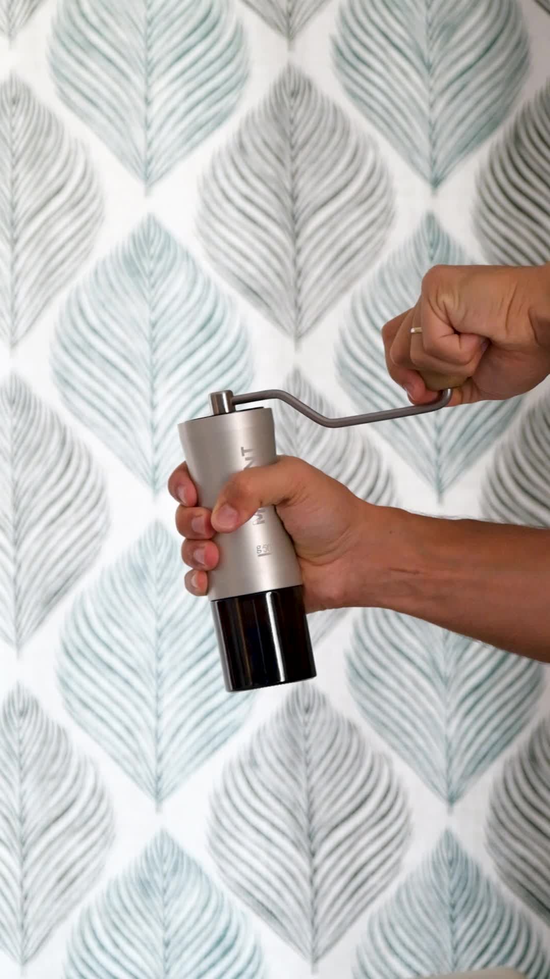 Hand Cranking Manual Coffee Grinder Against Patterned Background Free ...