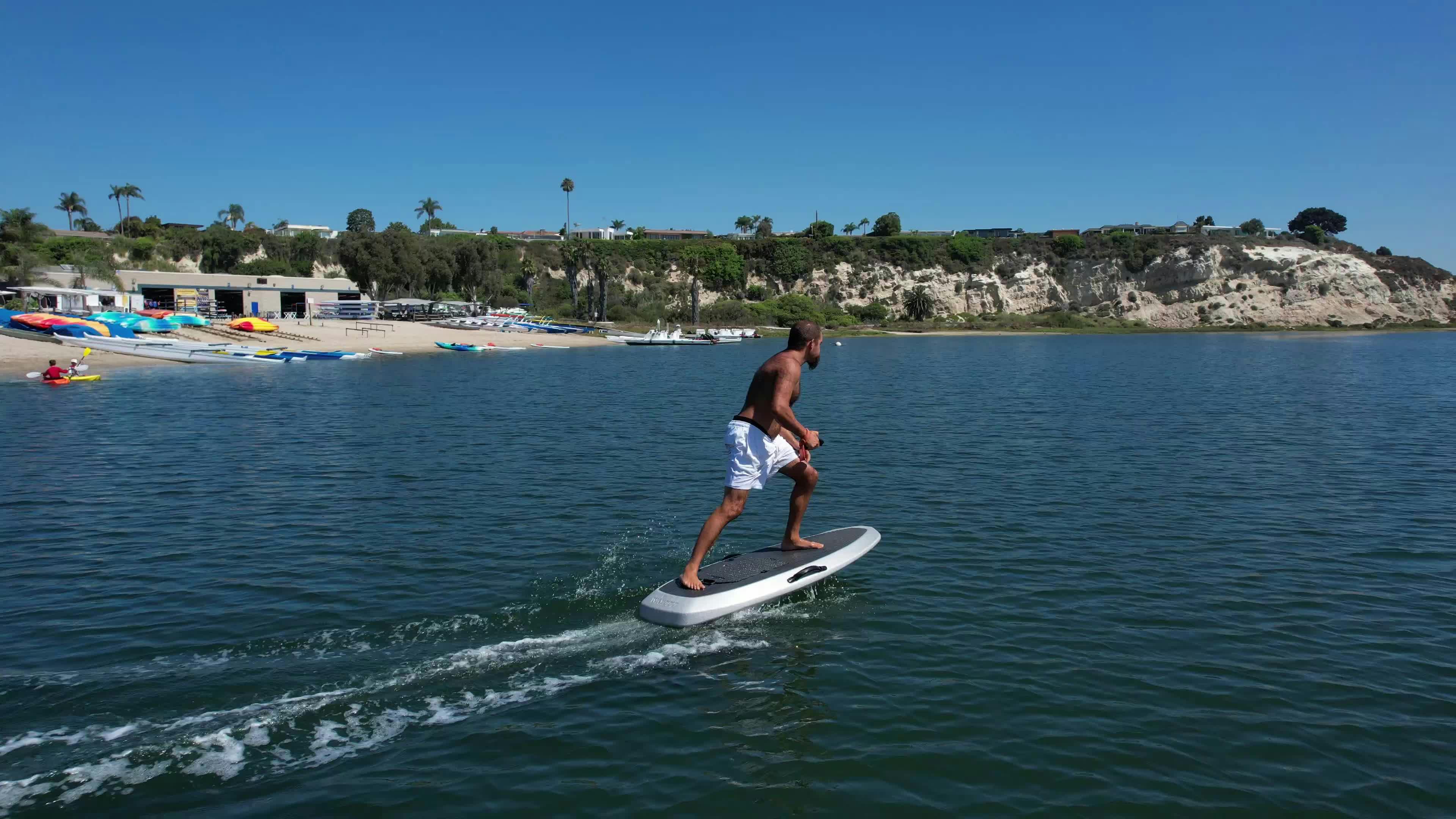 A man riding a stand up paddle board in the water Free Stock Video ...