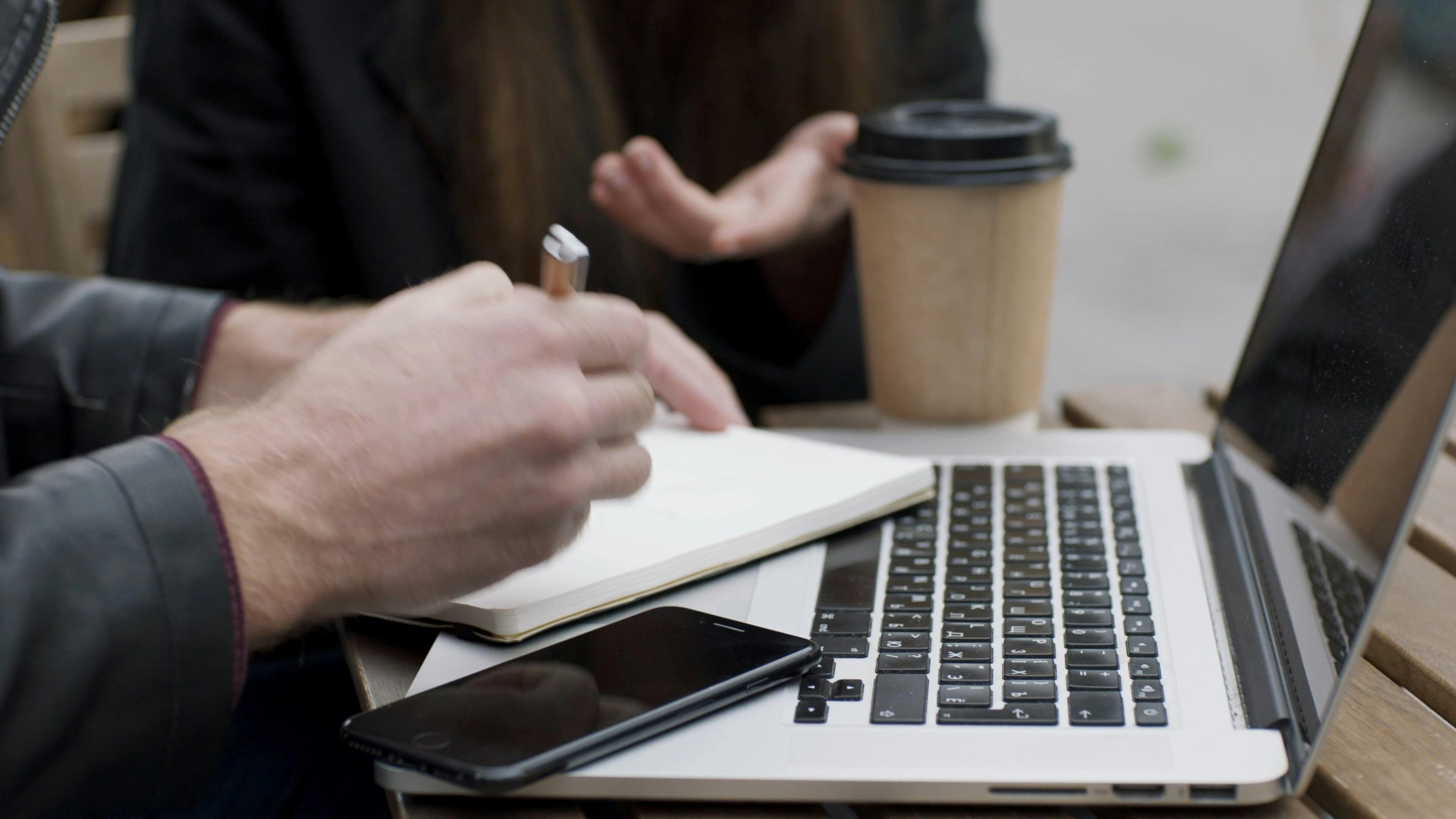 Using A Laptop While Taking Notes · Free Stock Video