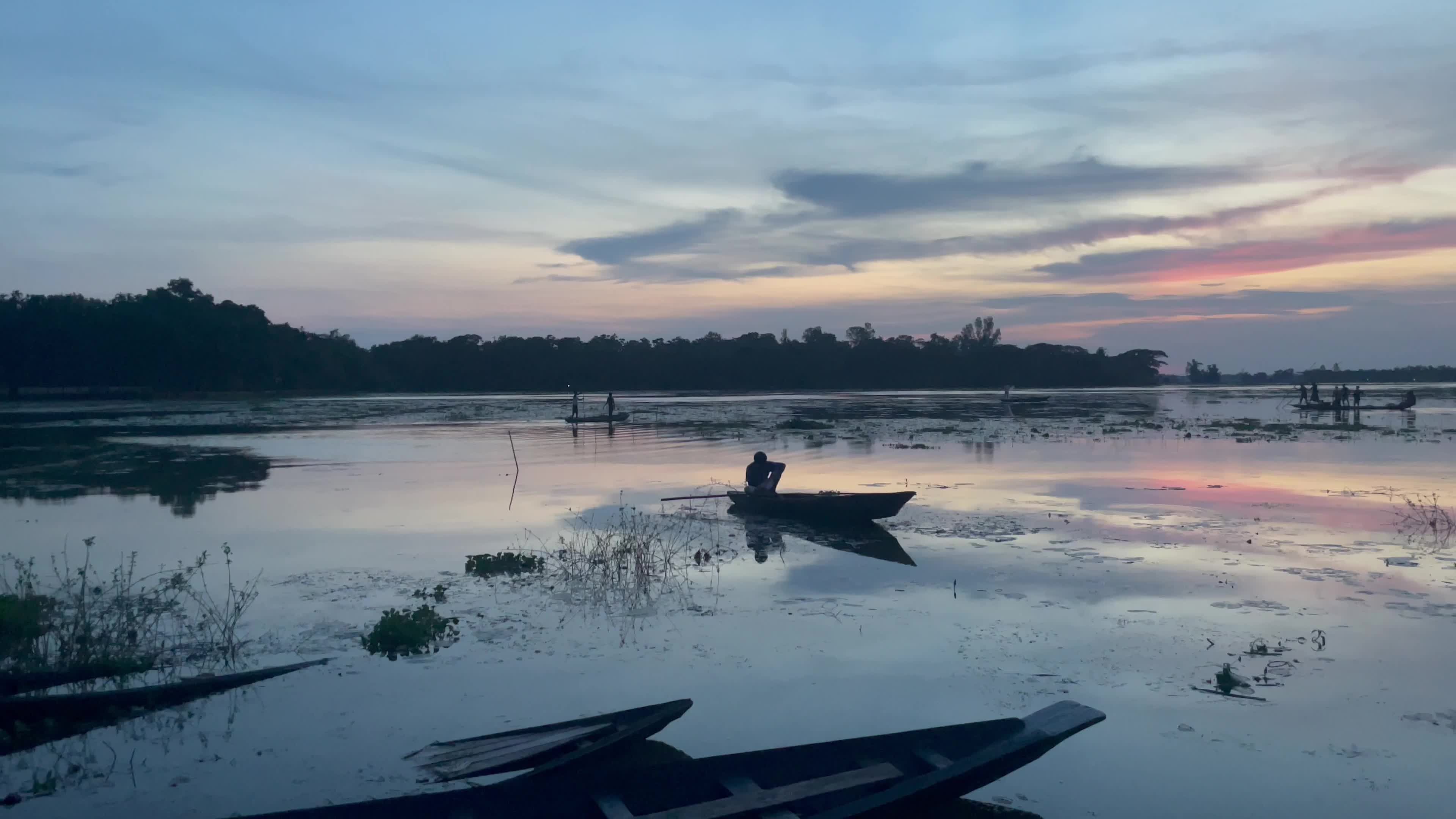A man is sitting in a boat on the water Free Stock Video Footage ...
