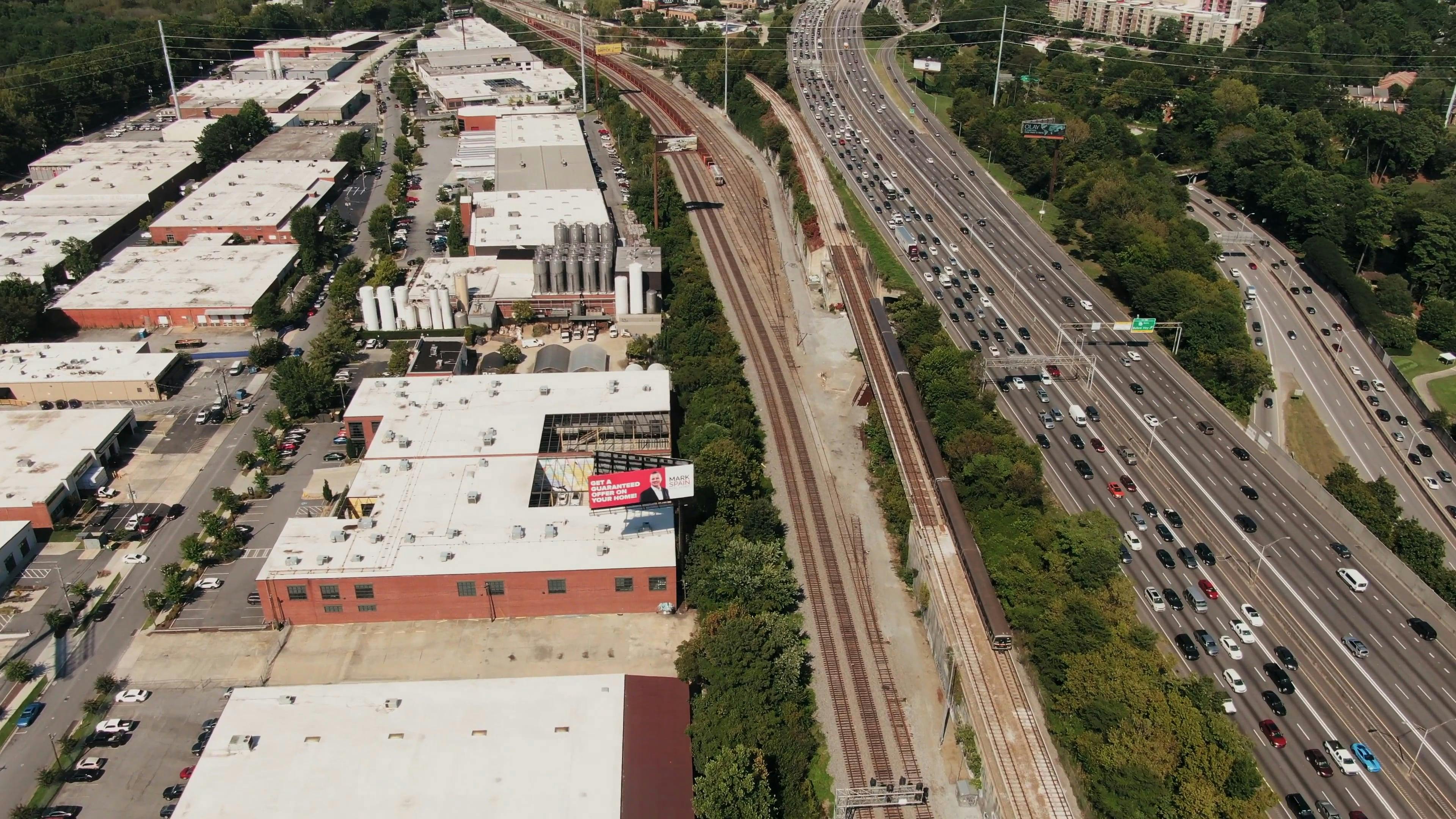 A Railroad Train In The Middle Of The Freeway And Residential Community ...