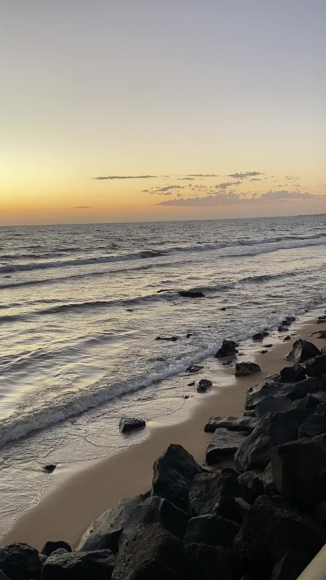 A beach with rocks and water at sunset Free Stock Video Footage ...