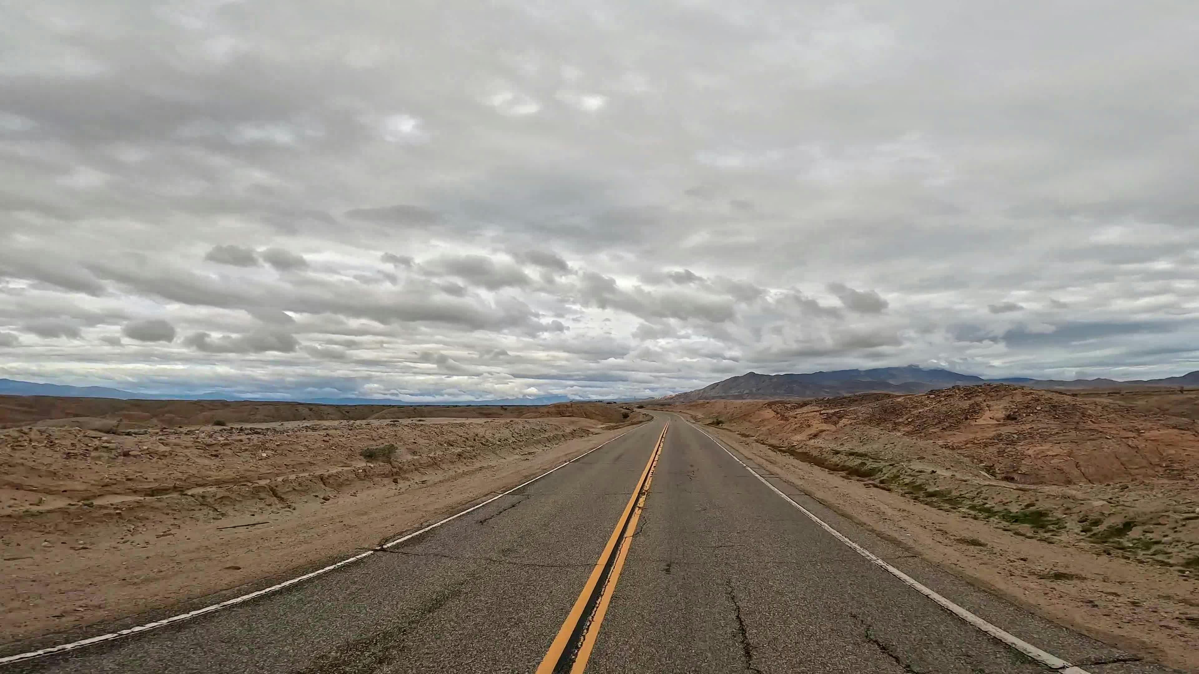 A desert road with a sign that says, the road is open Free Stock Video ...