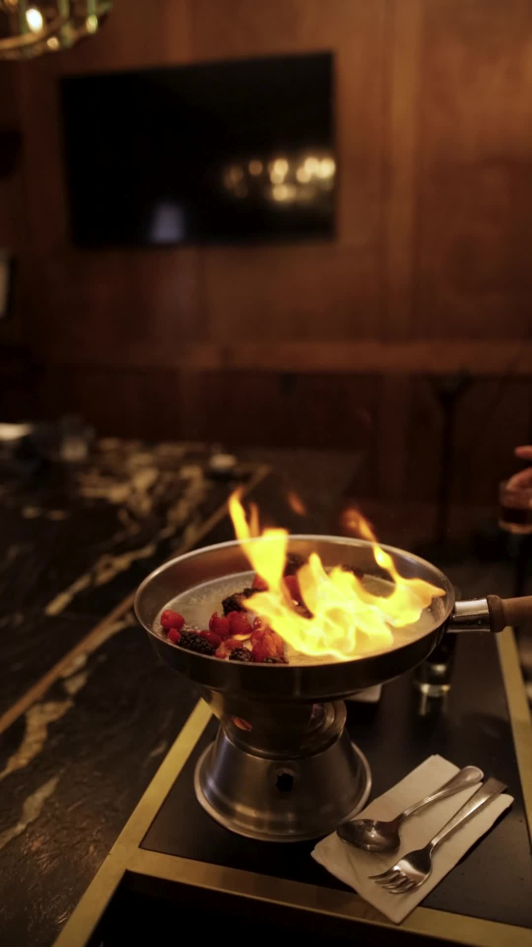 A Flaming Dessert On A Table With A Glass Of Wine Free Stock Video