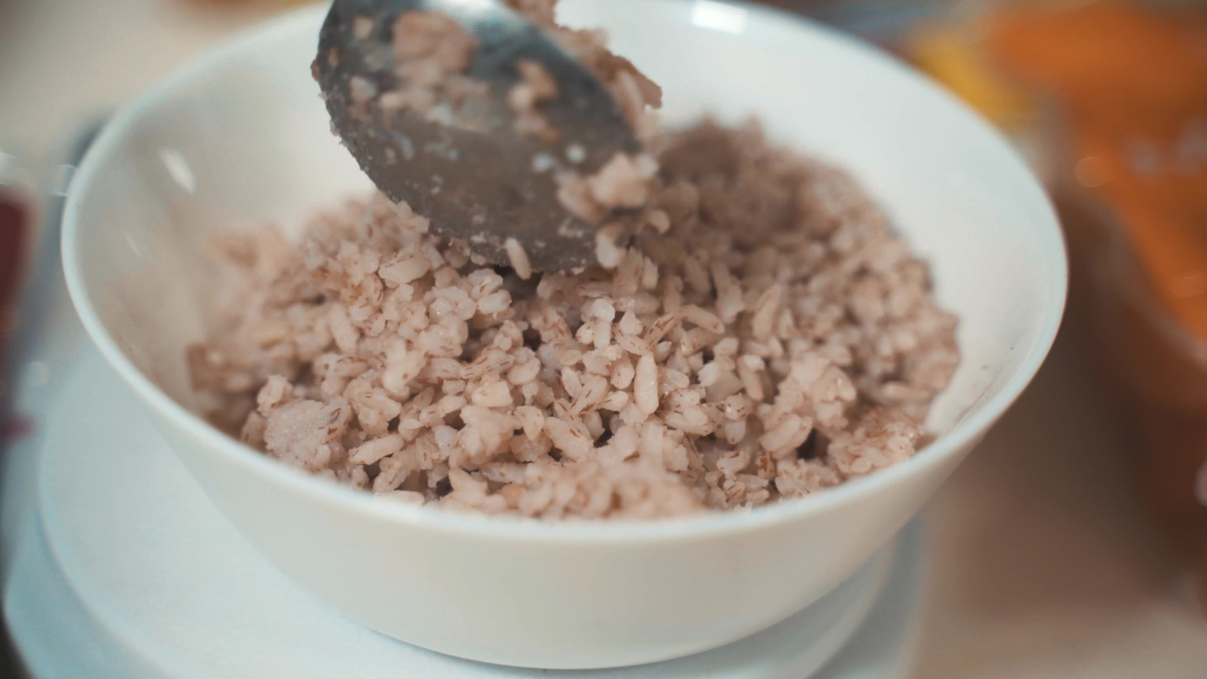 A person is spooning rice into a bowl Free Stock Video Footage, Royalty ...