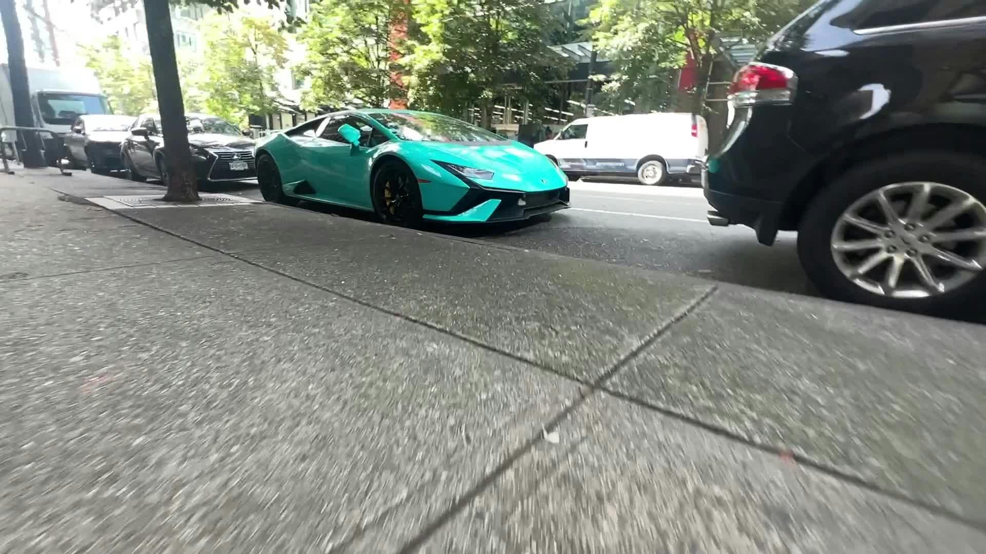 A turquoise lamb car parked on the side of the road Free Stock Video ...