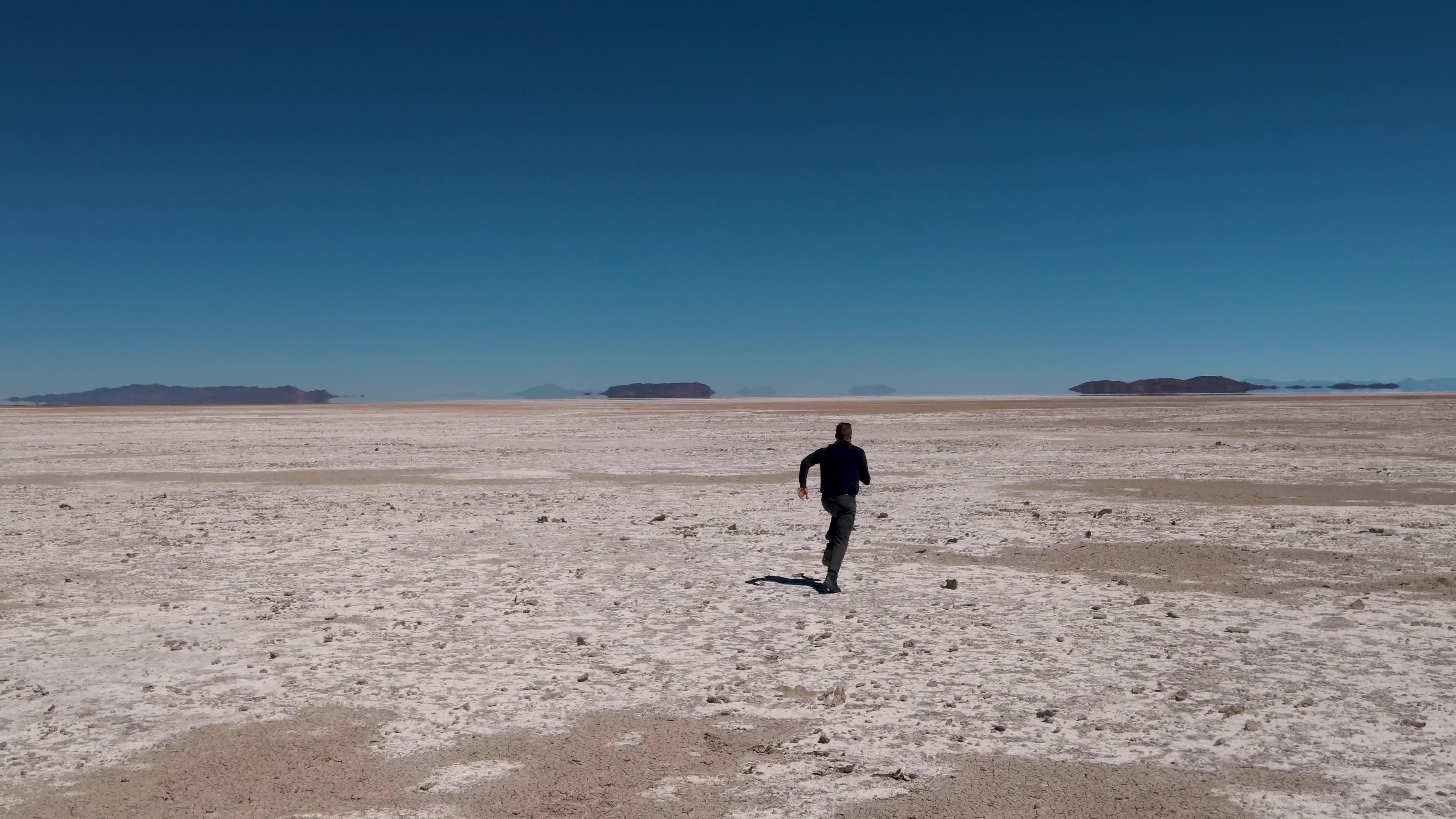 Man Running Across Vast Salt Flats in Bolivia Free Stock Video Footage ...
