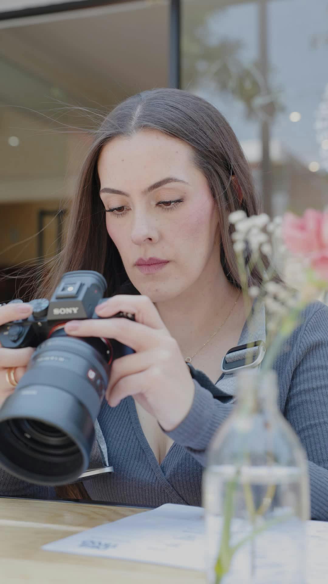 Female Photographer Reviewing Camera at Café Free Stock Video Footage ...