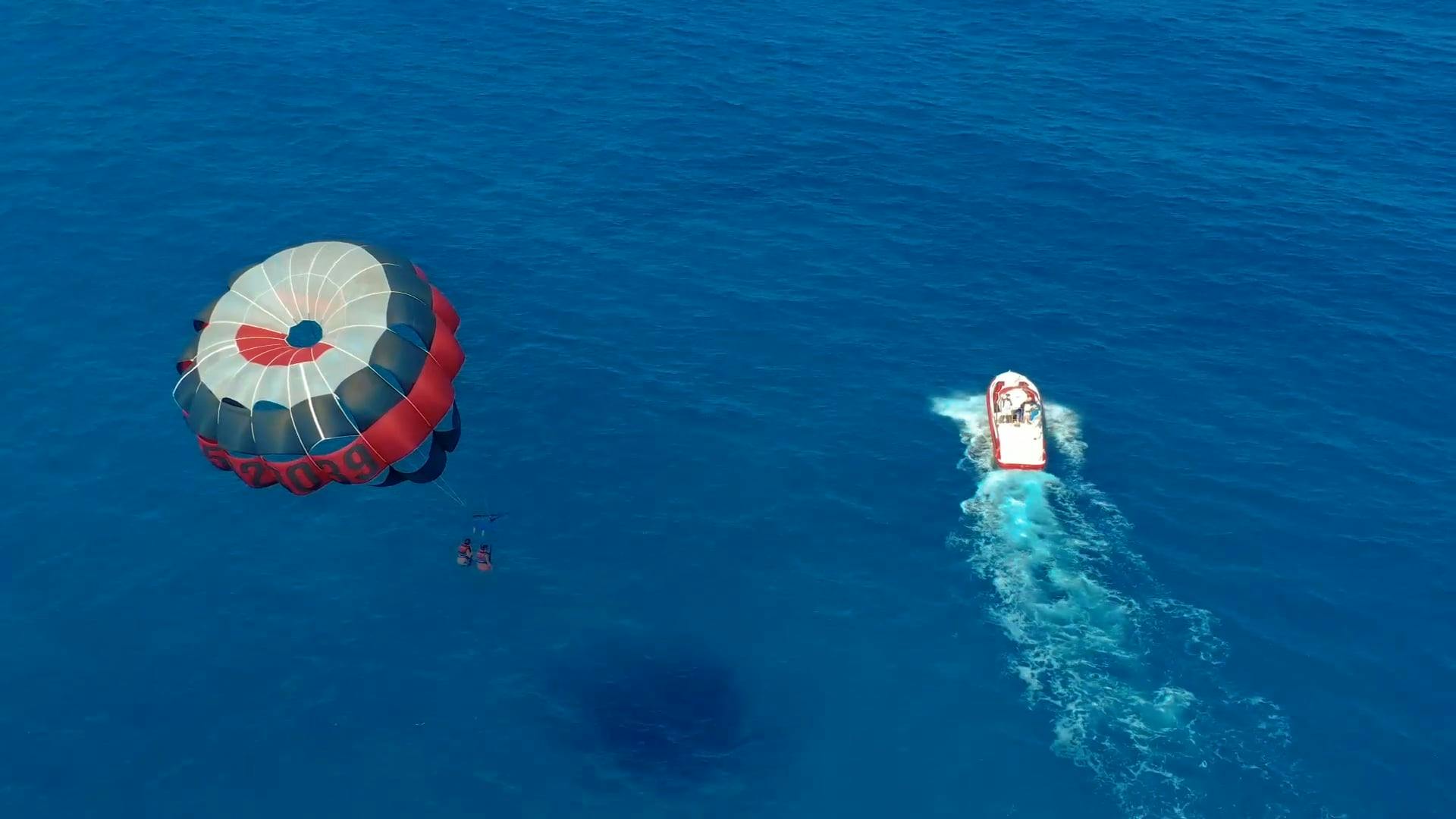 A Couple Paragliding Over The Blue Water Of The Sea · Free Stock Video