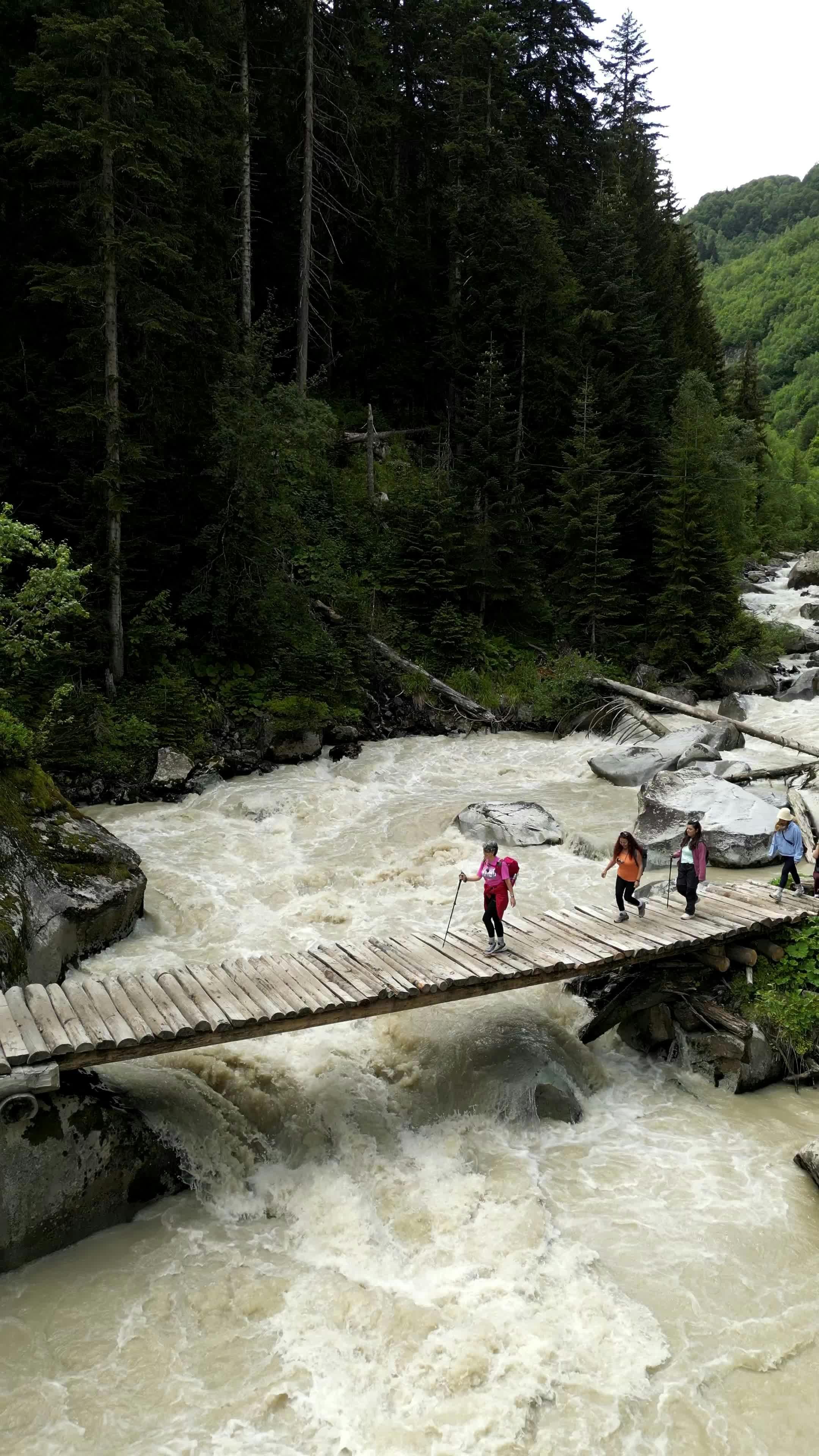People Crossing Wooden Bridge Over Rapid River Free Stock Video Footage ...