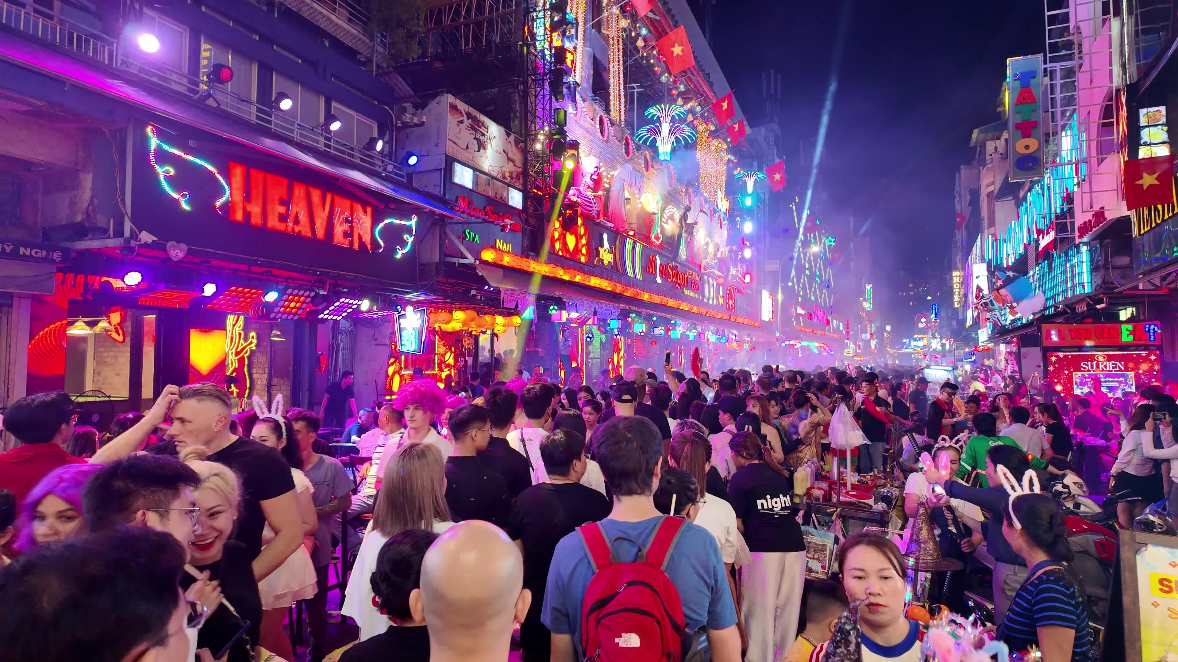 Vibrant Nightlife Street with Neon Lights and Crowd Free Stock Video ...
