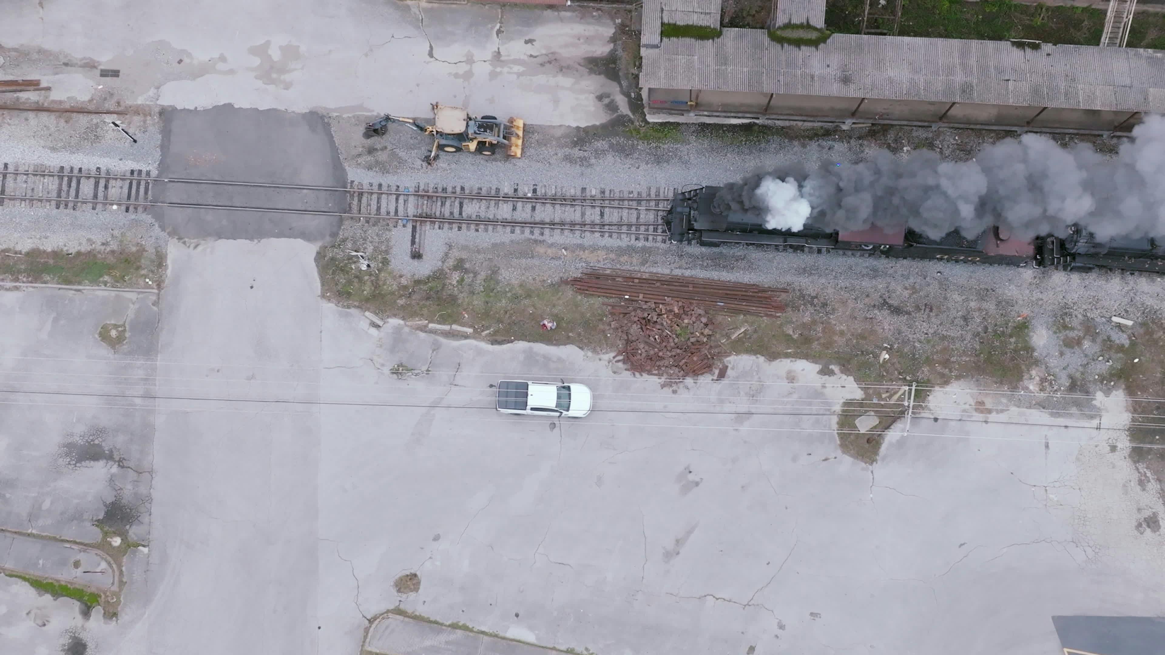 Aerial View of Steam Train Passing Warehouse Area Free Stock Video ...