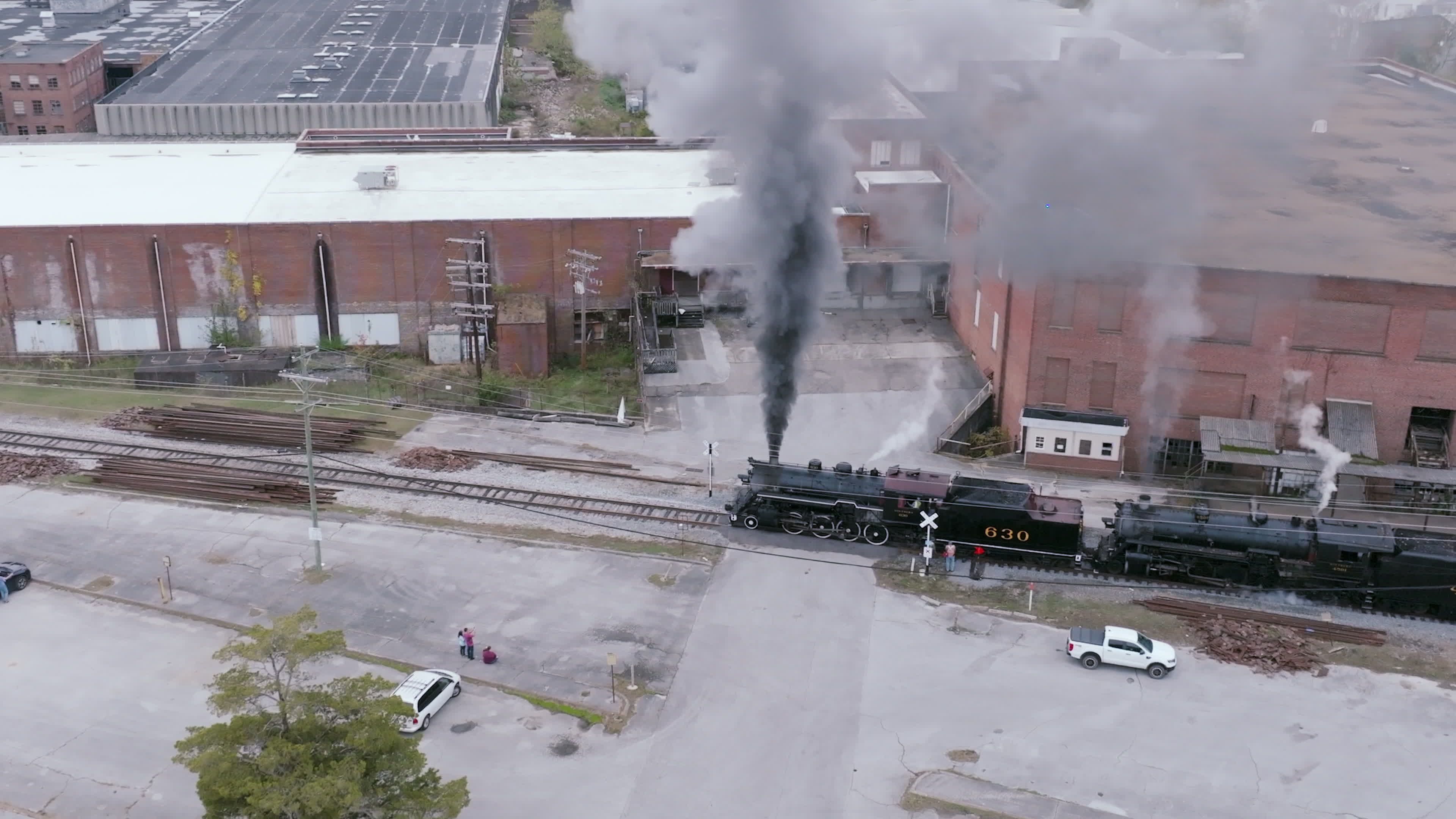 Historic Steam Train Passing Industrial Warehouse Free Stock Video ...