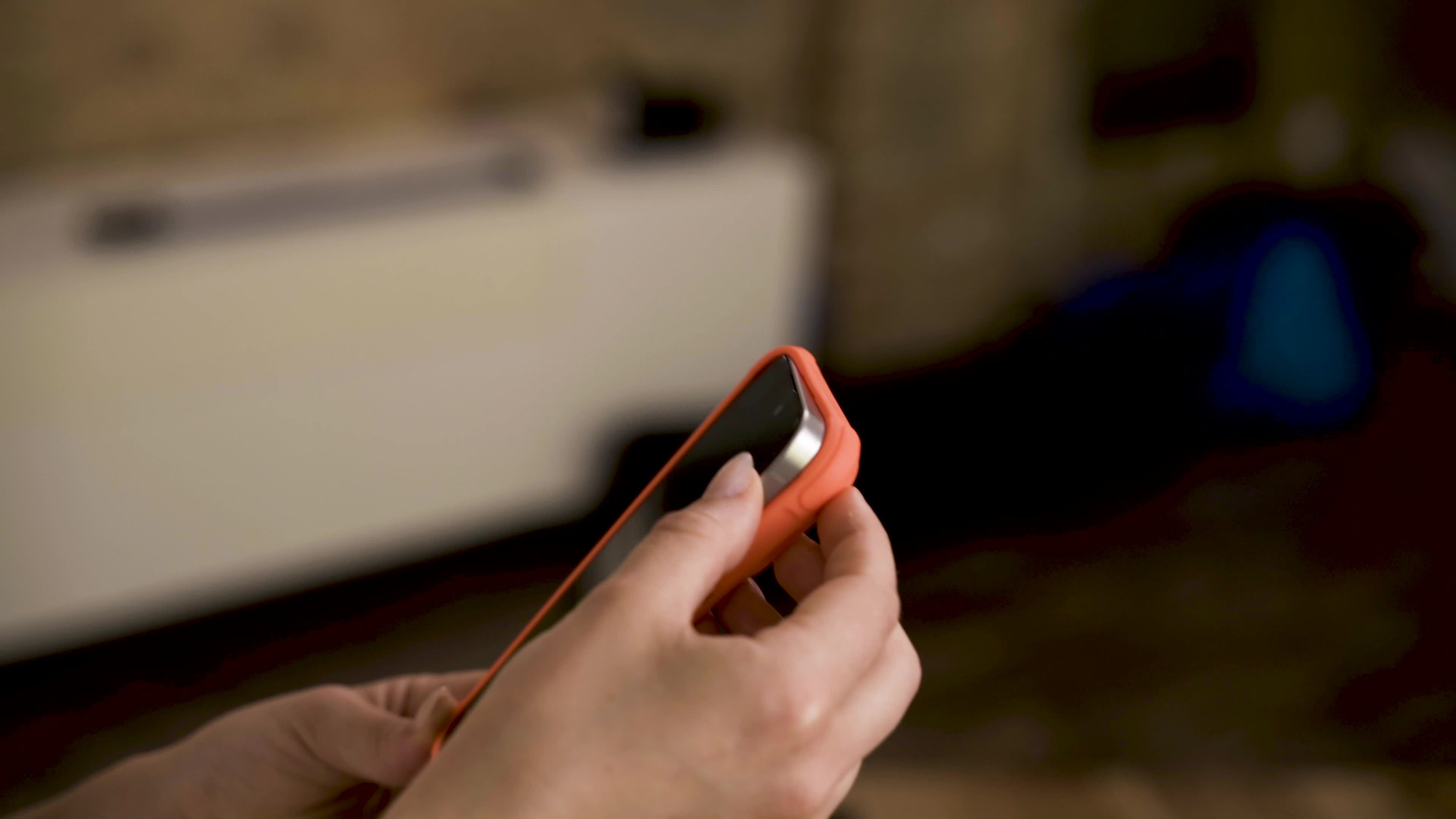 Close-up of Woman's Hands Holding Smartphone with Orange Case Free ...