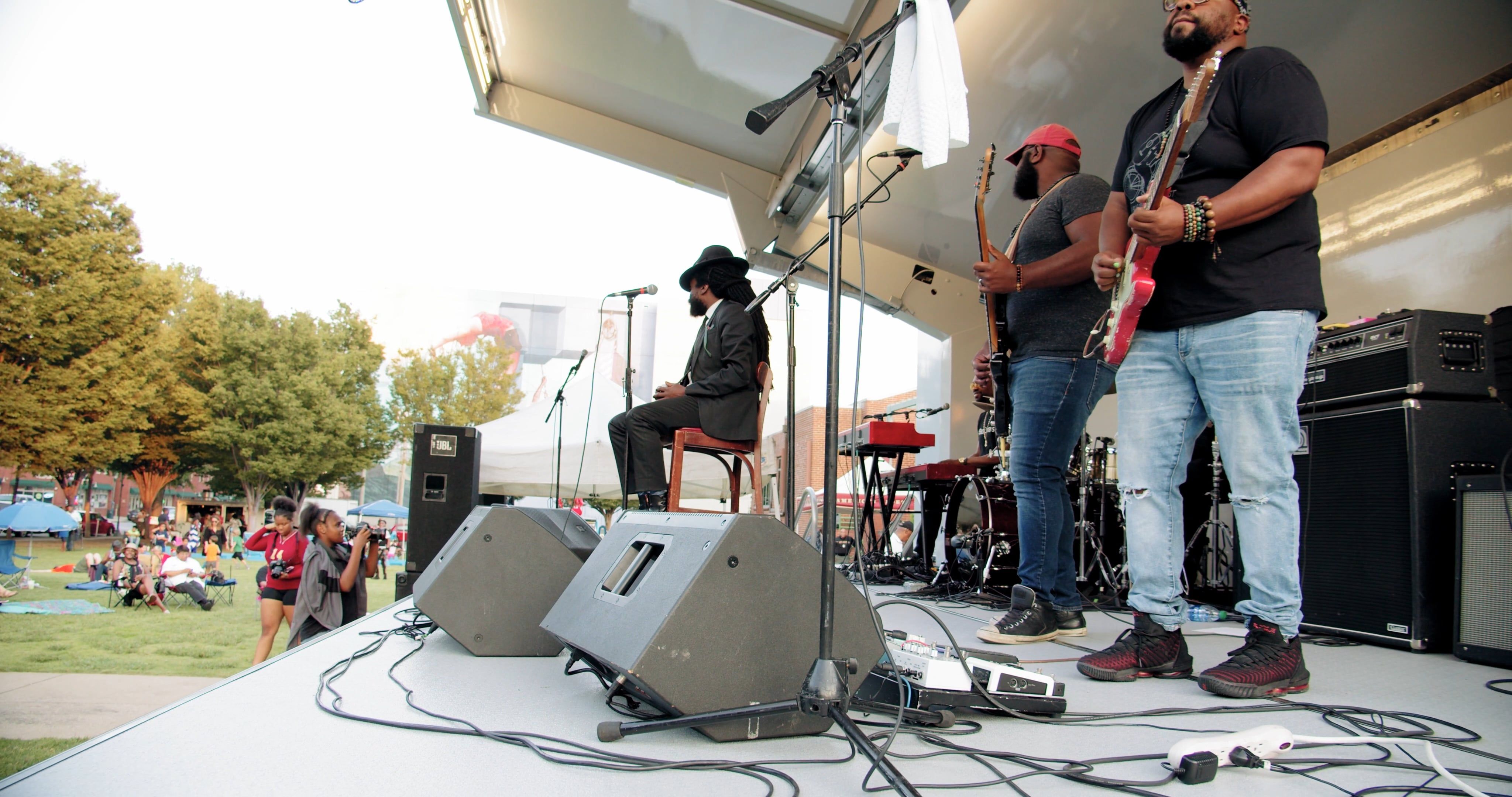 A Musician Trio Performs On A Stage In An Outdoors Setting Free Stock ...