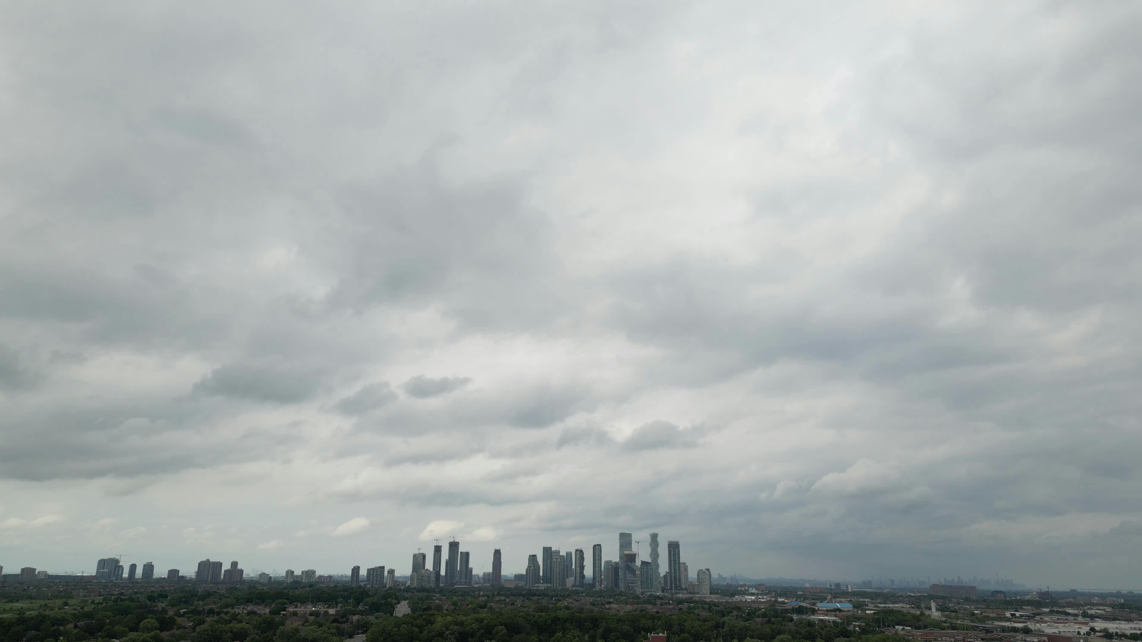Aerial View of Urban Skyline Under Cloudy Sky Free Stock Video Footage ...