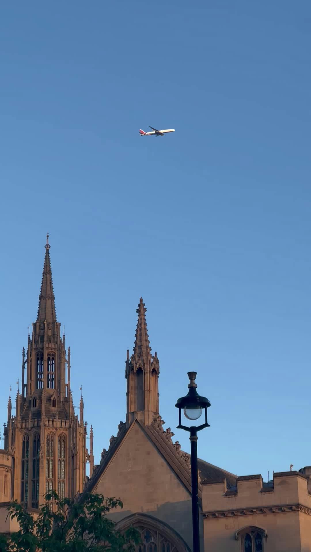 Airplane Flying Over Gothic Architecture at Dusk Free Stock Video ...