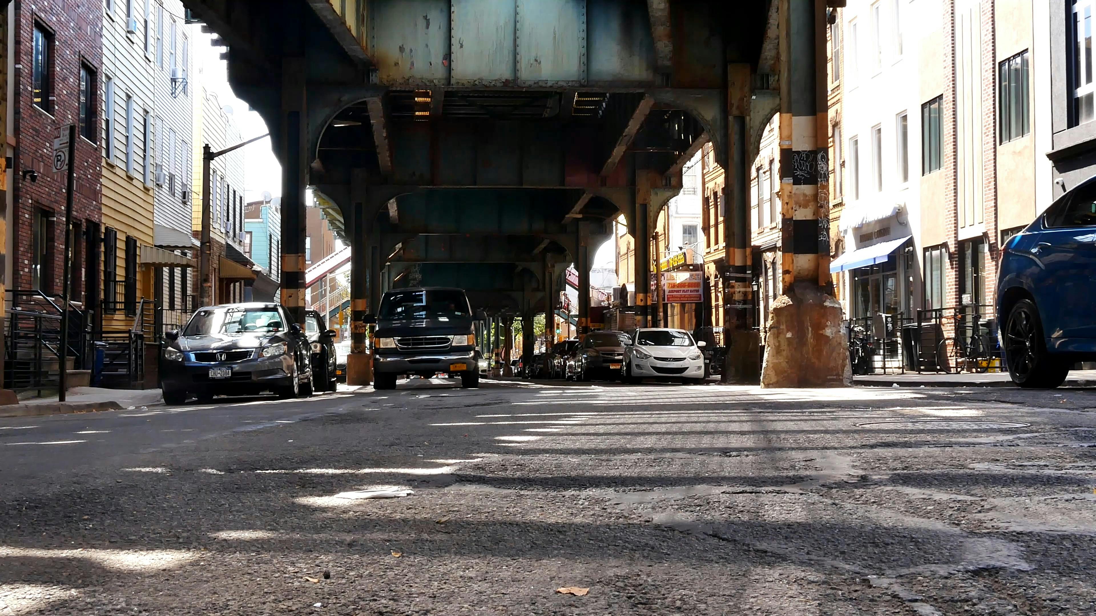 Vehicles Taking Parking Space On The City Side Street Under A Bridge ...