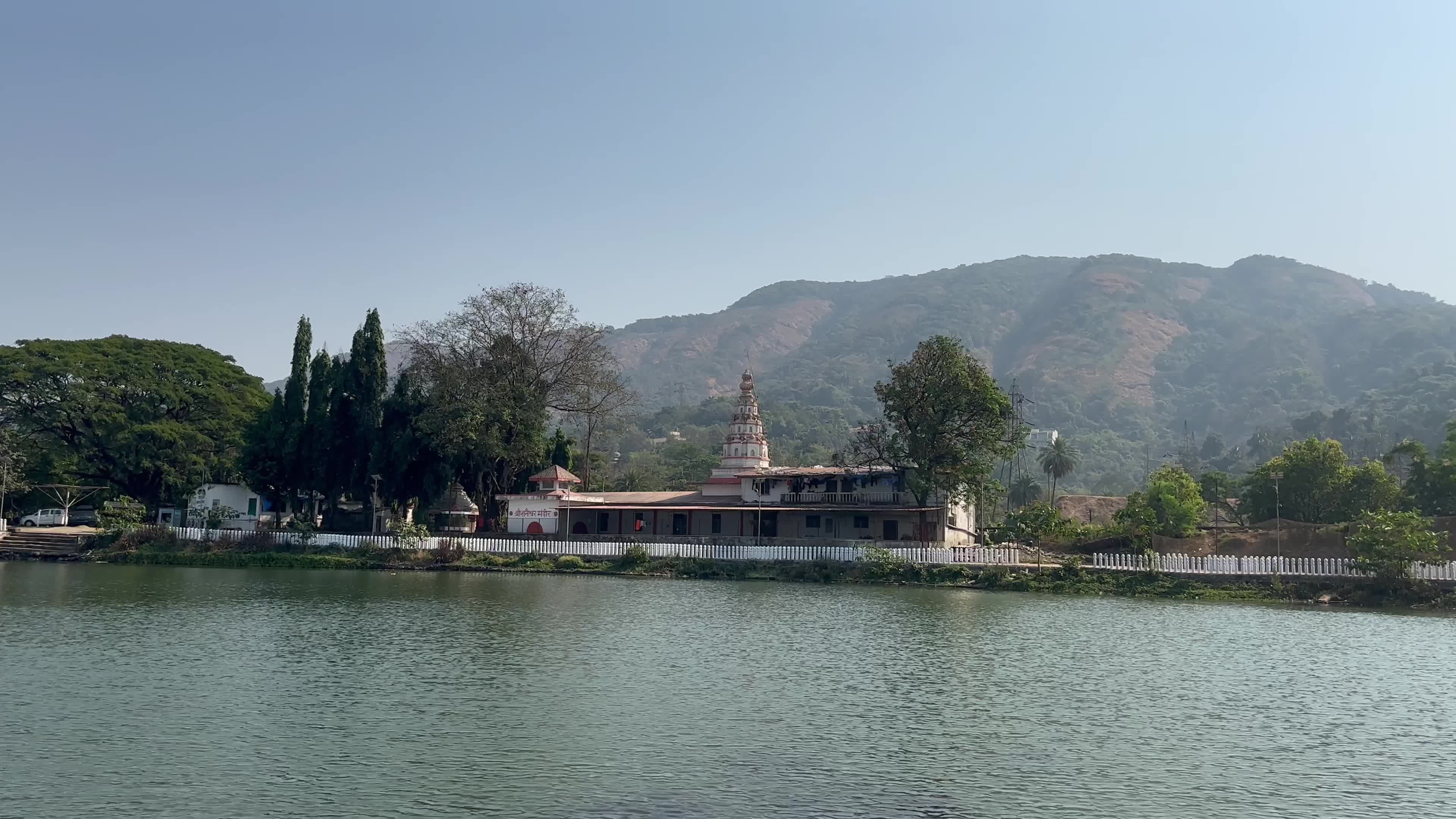 Serene Riverside Temple with Mountain Backdrop Free Stock Video Footage ...