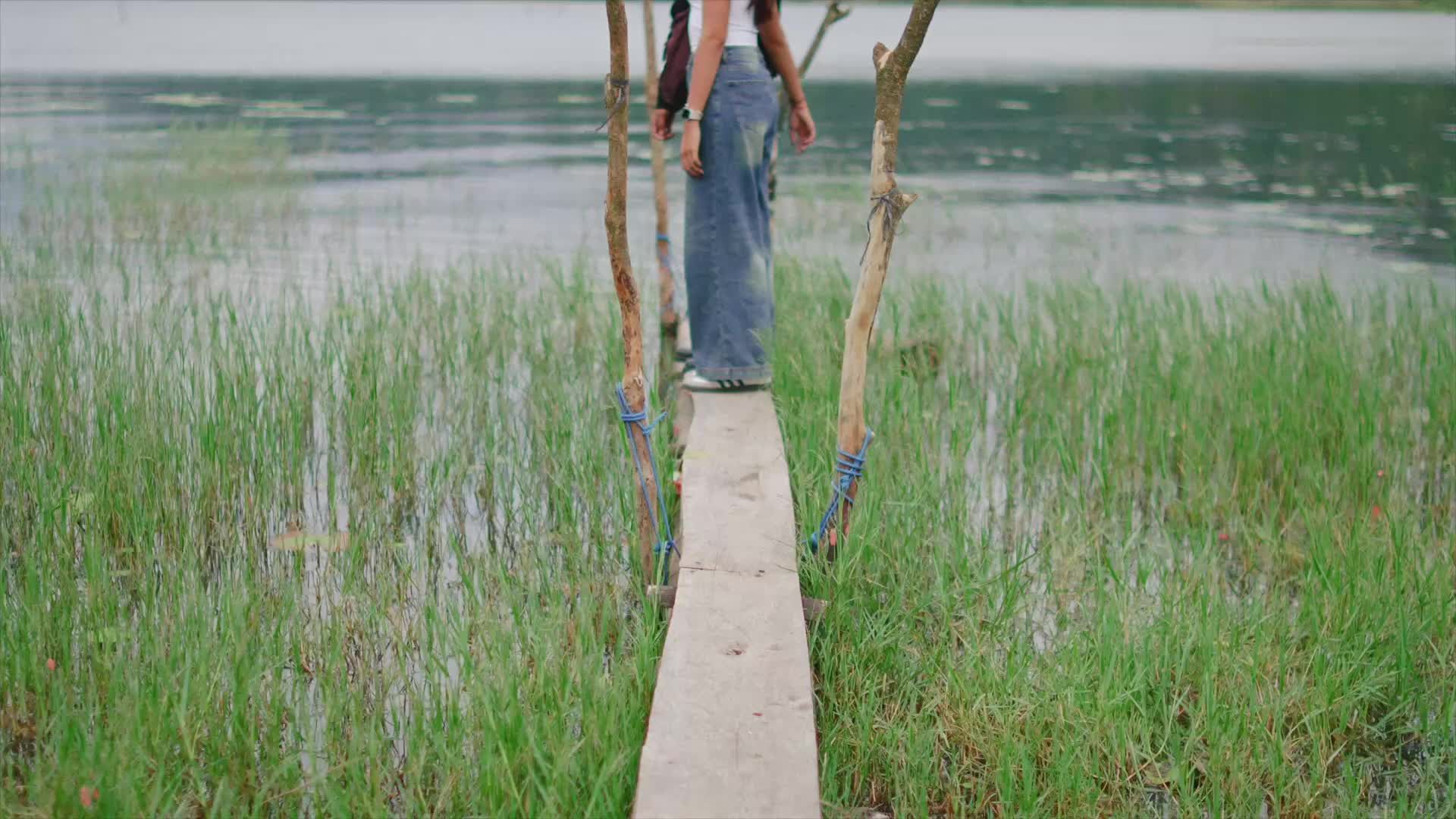 Person Walking on Narrow Bridge Over Water Free Stock Video Footage ...