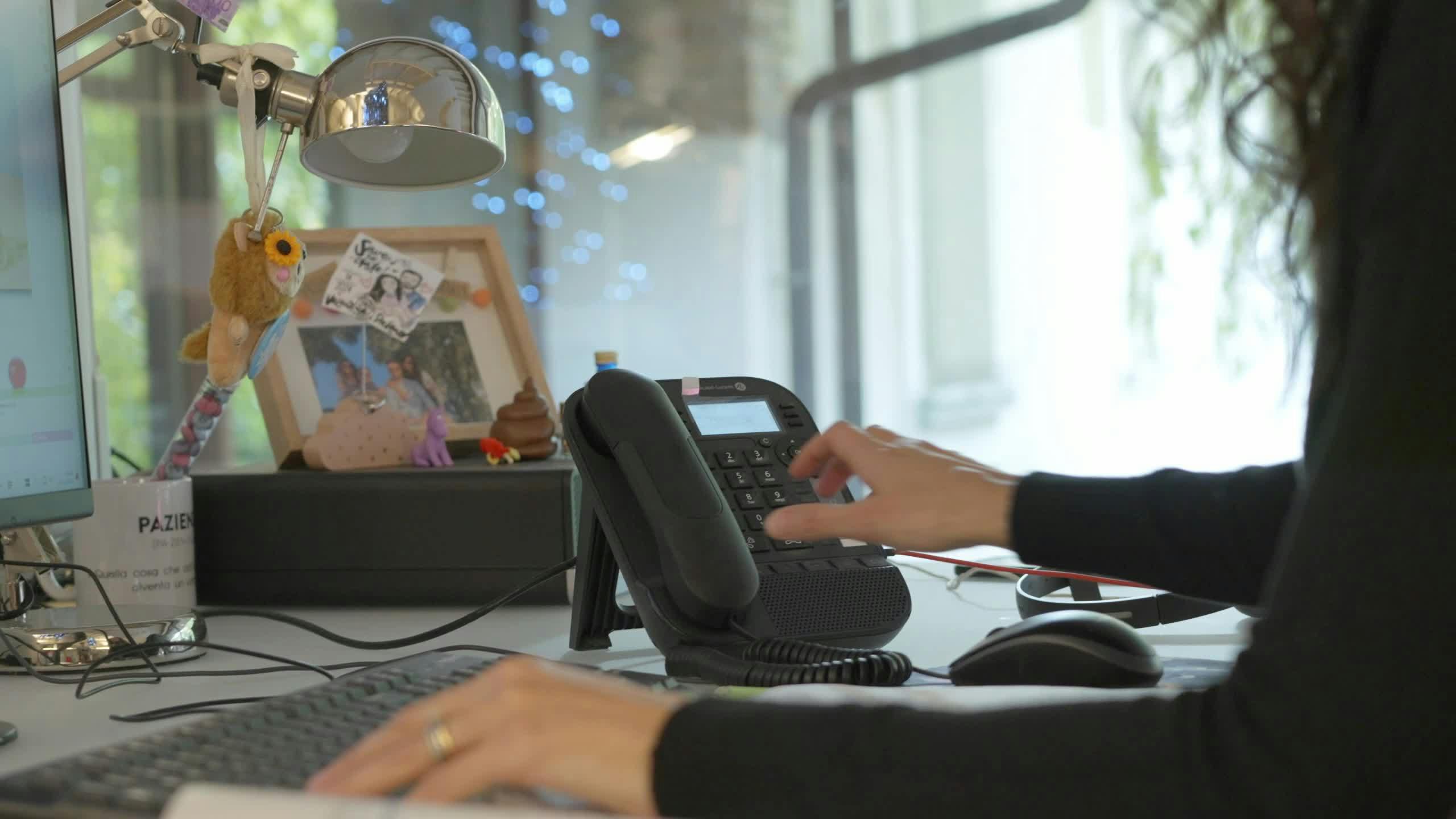 Businesswoman using office phone in modern workspace Free Stock Video ...