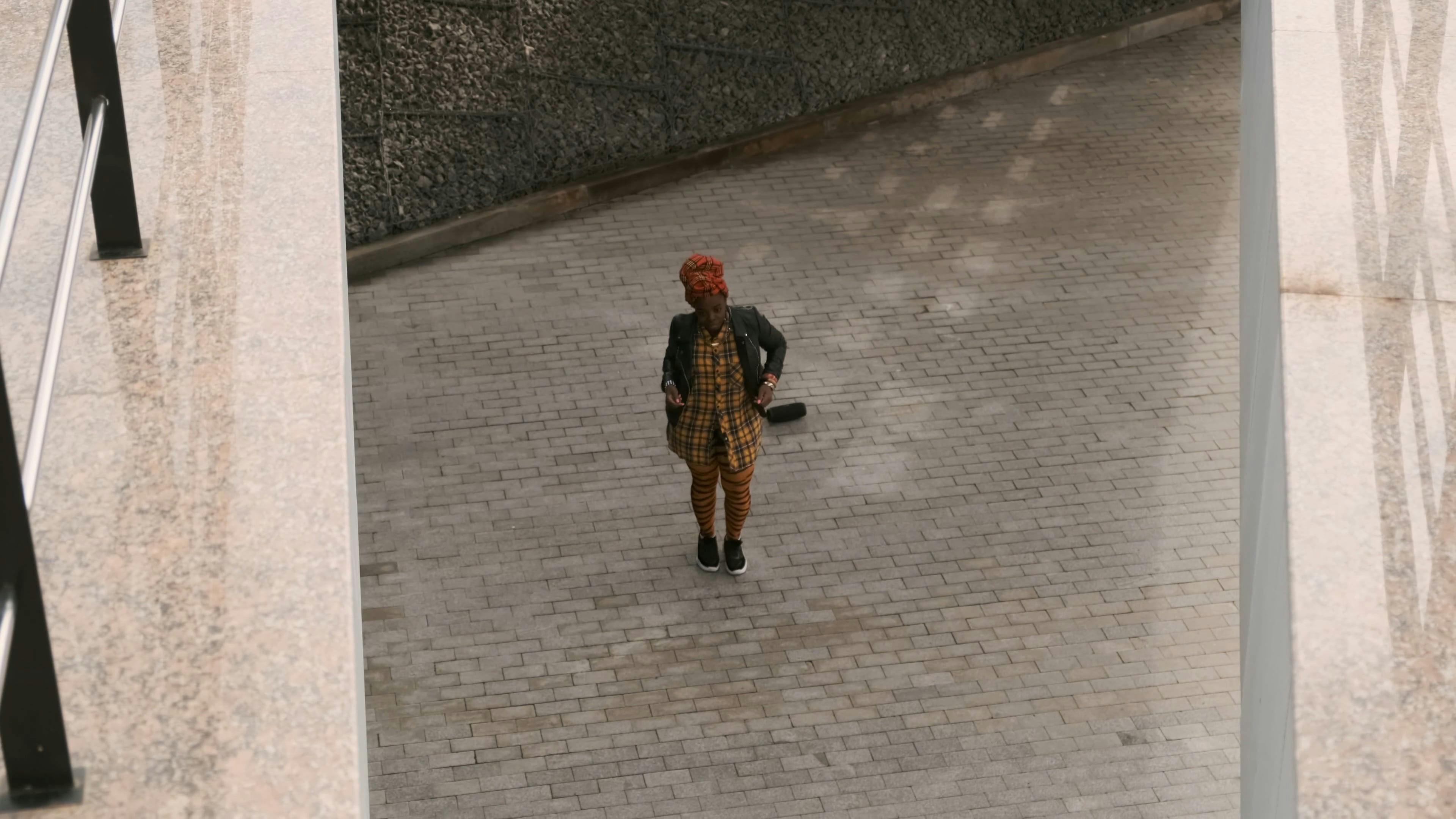 A Woman Dancing Freely Outdoors On A Concrete Pavement Free Stock Video ...